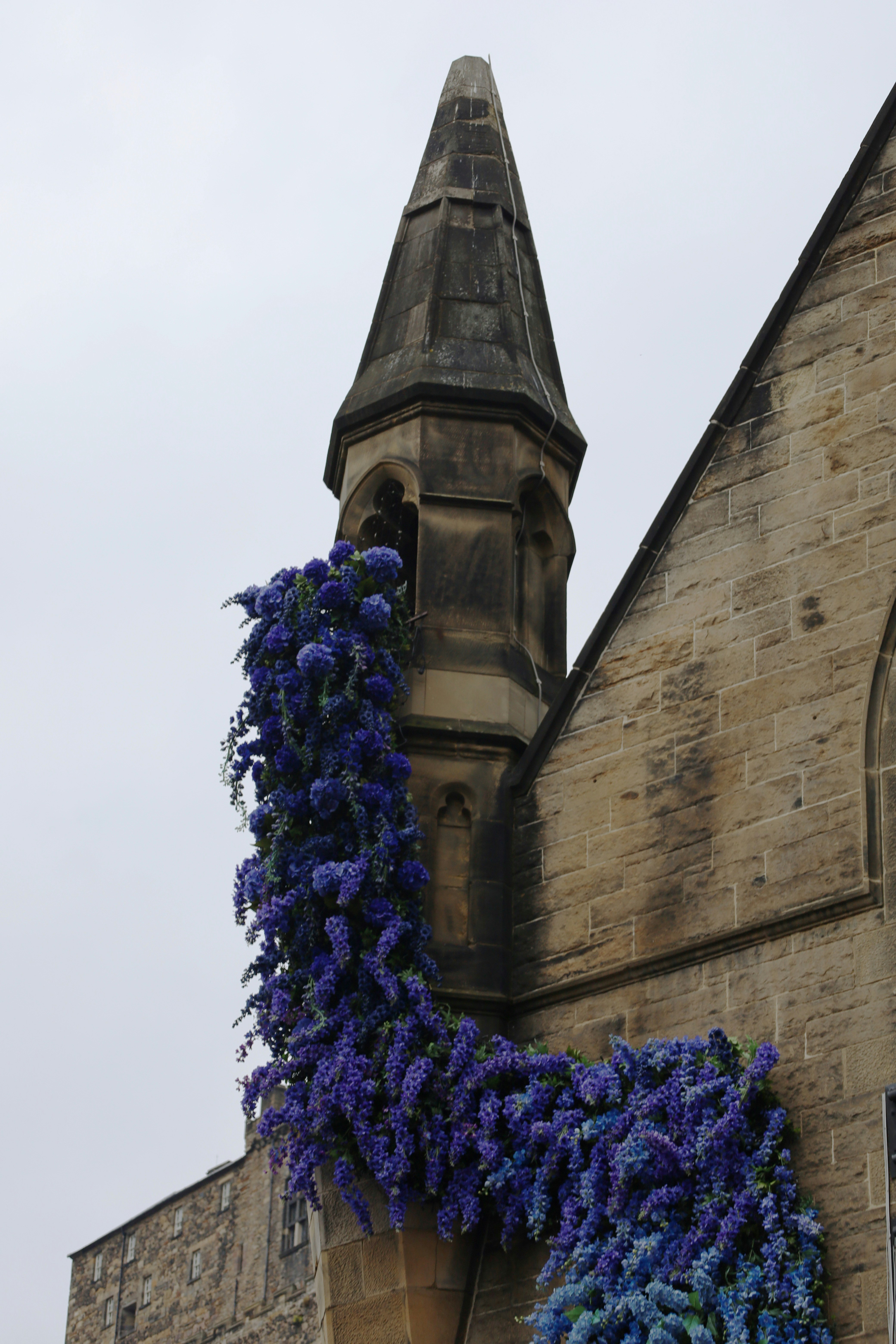 Stone Turret Adorned with Cascading Indigo Blooms