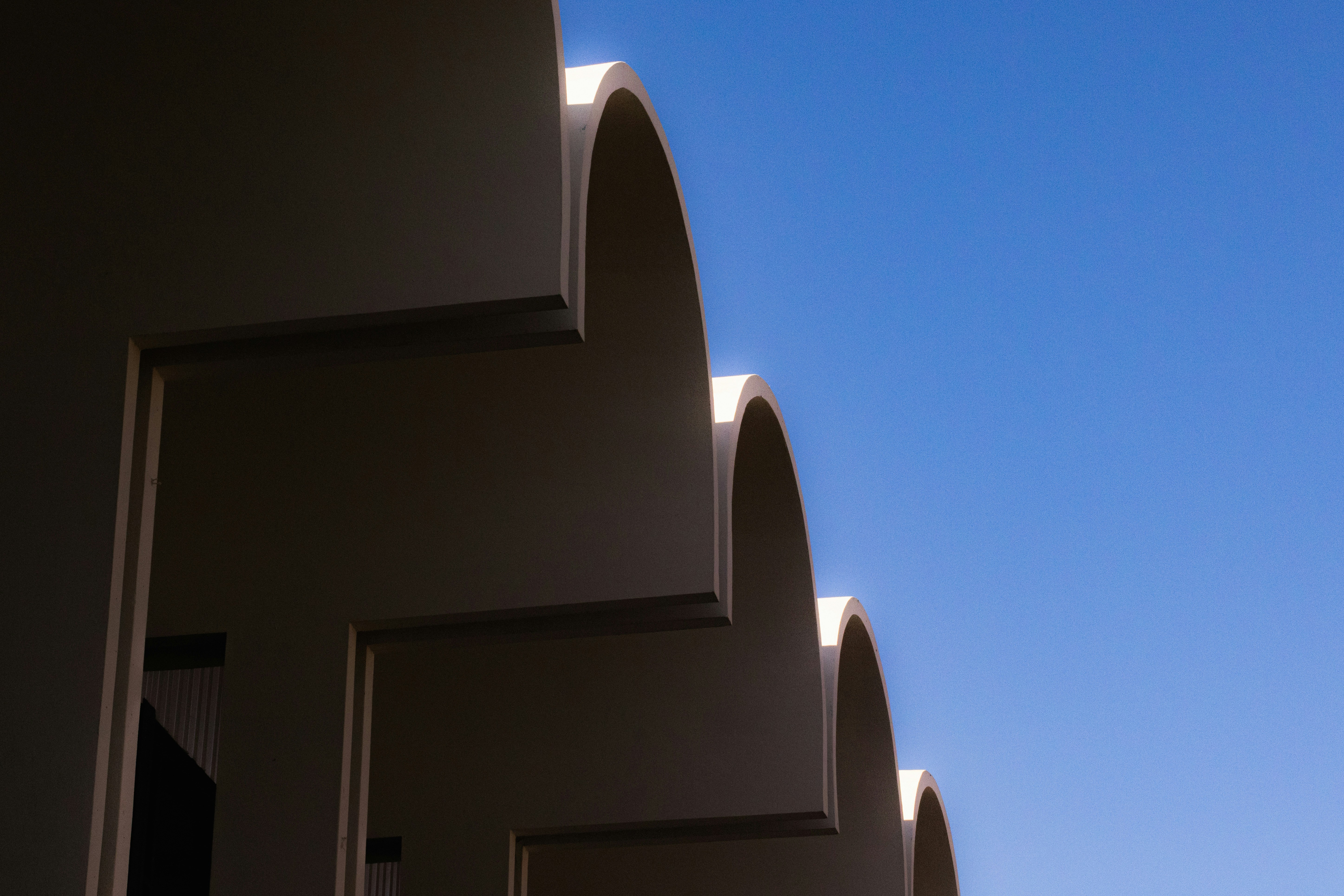 Architectural Echoes: Curved Canopies Against a Clear Sky