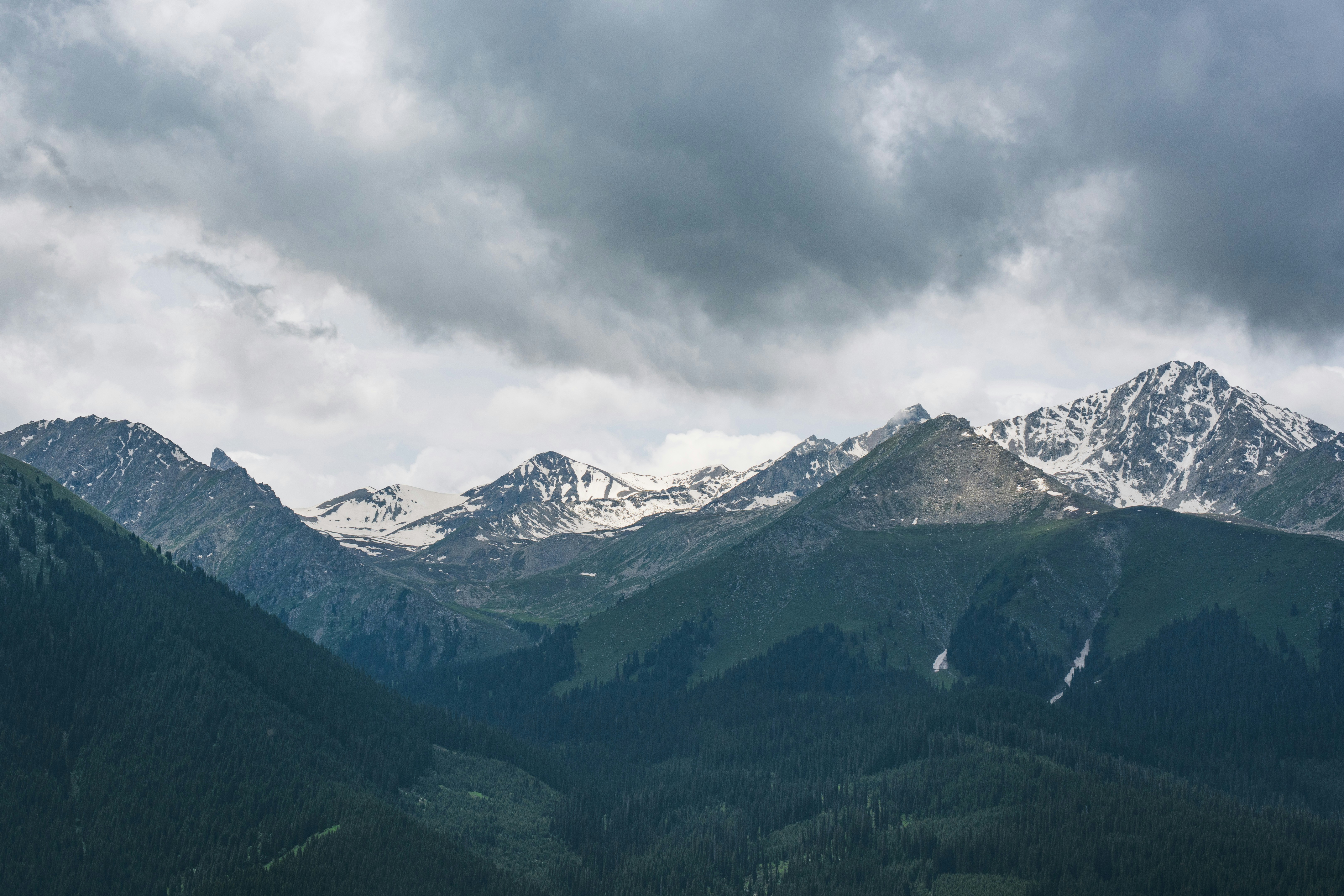 Snow-capped Peaks Over Verdant Valleys at Twilight