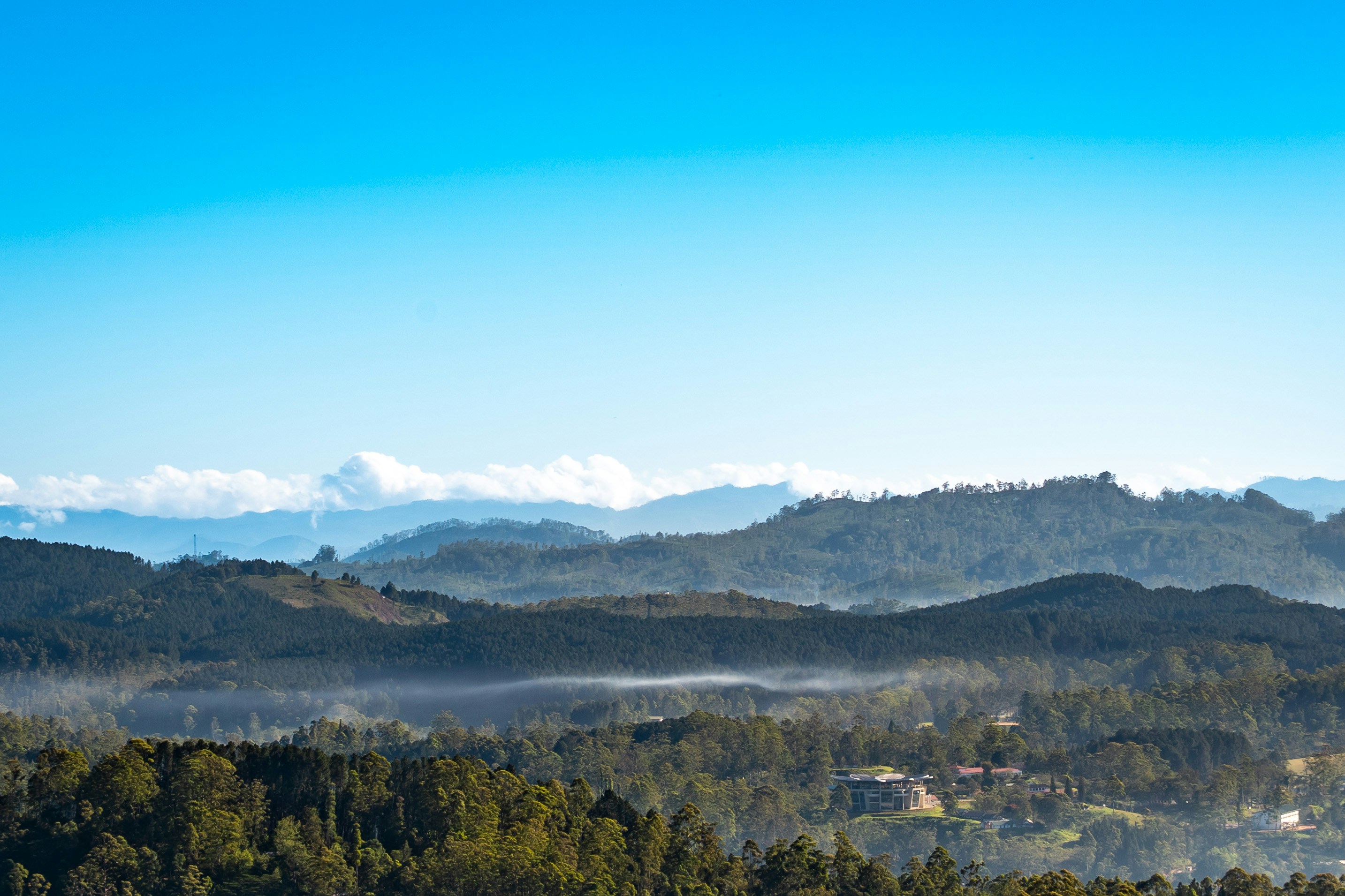 Horizon Layers: Distant Hills Beneath a Clear Blue Skiescape