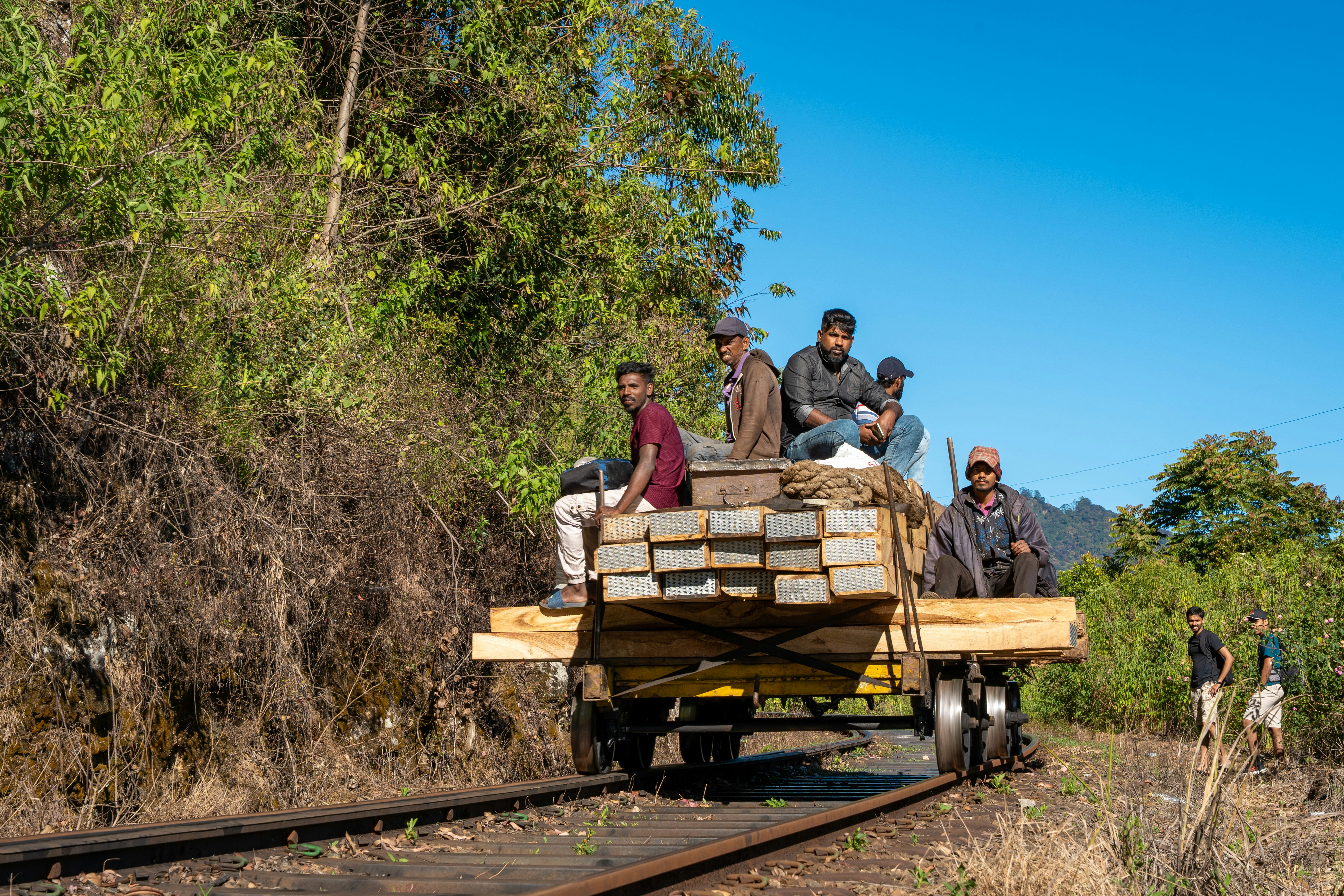 Railway Crew on a Loaded Cart: Journey through a Narrow-Gauge Track
