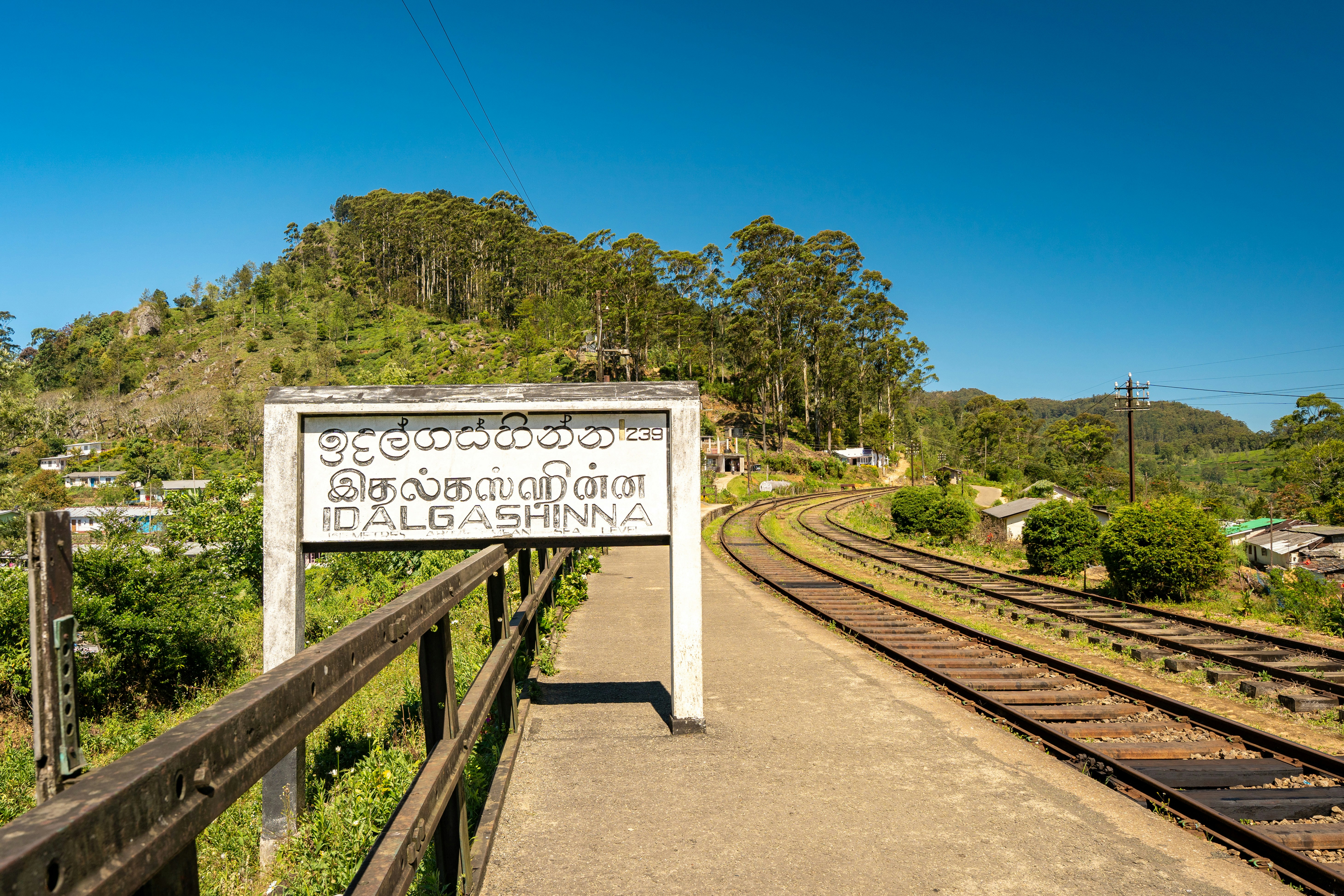 Railway Platform Signage Amid Shaded Hills