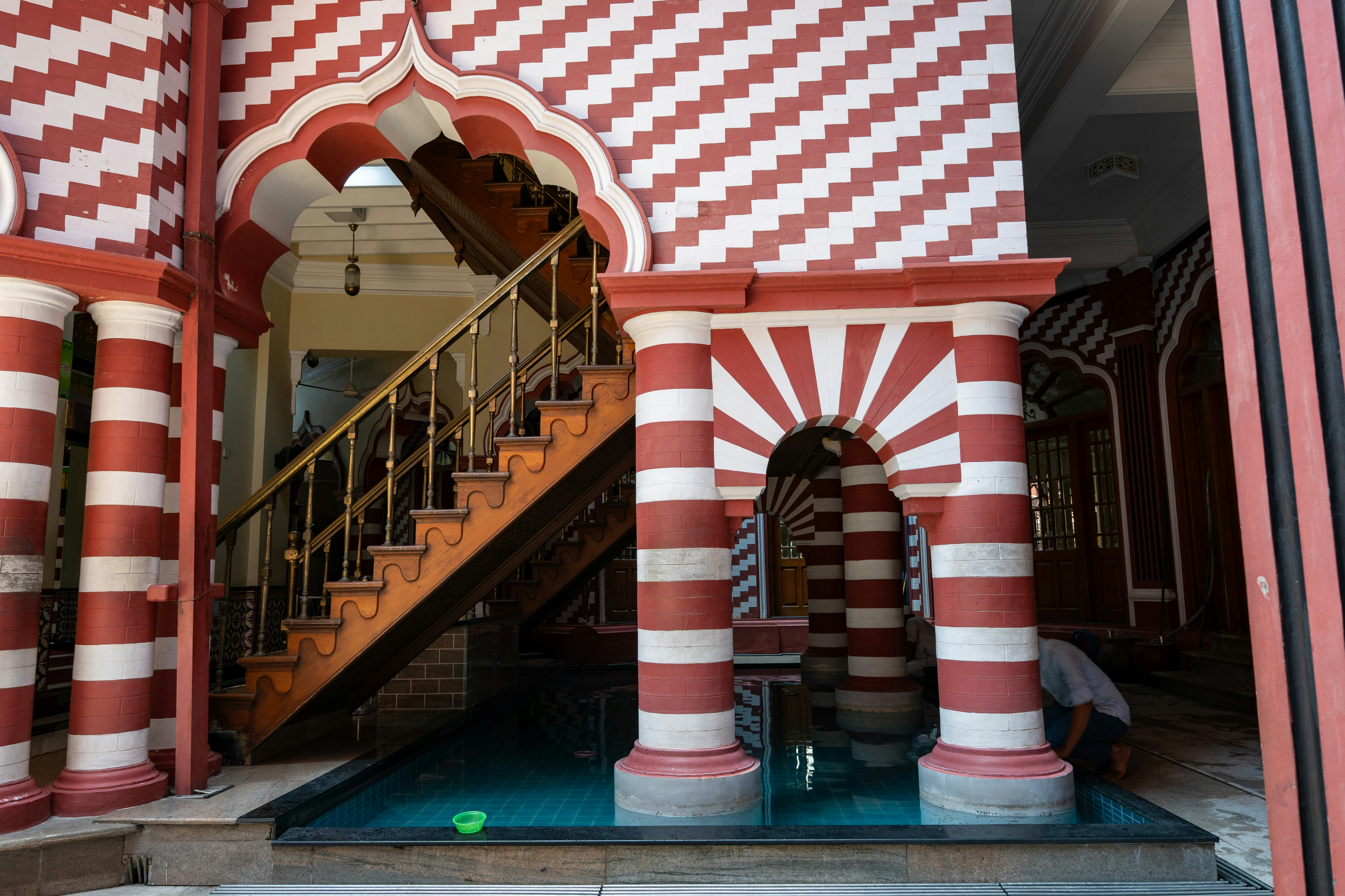 Stripes and Staircase: Red-and-White Archway Street at the Atrium