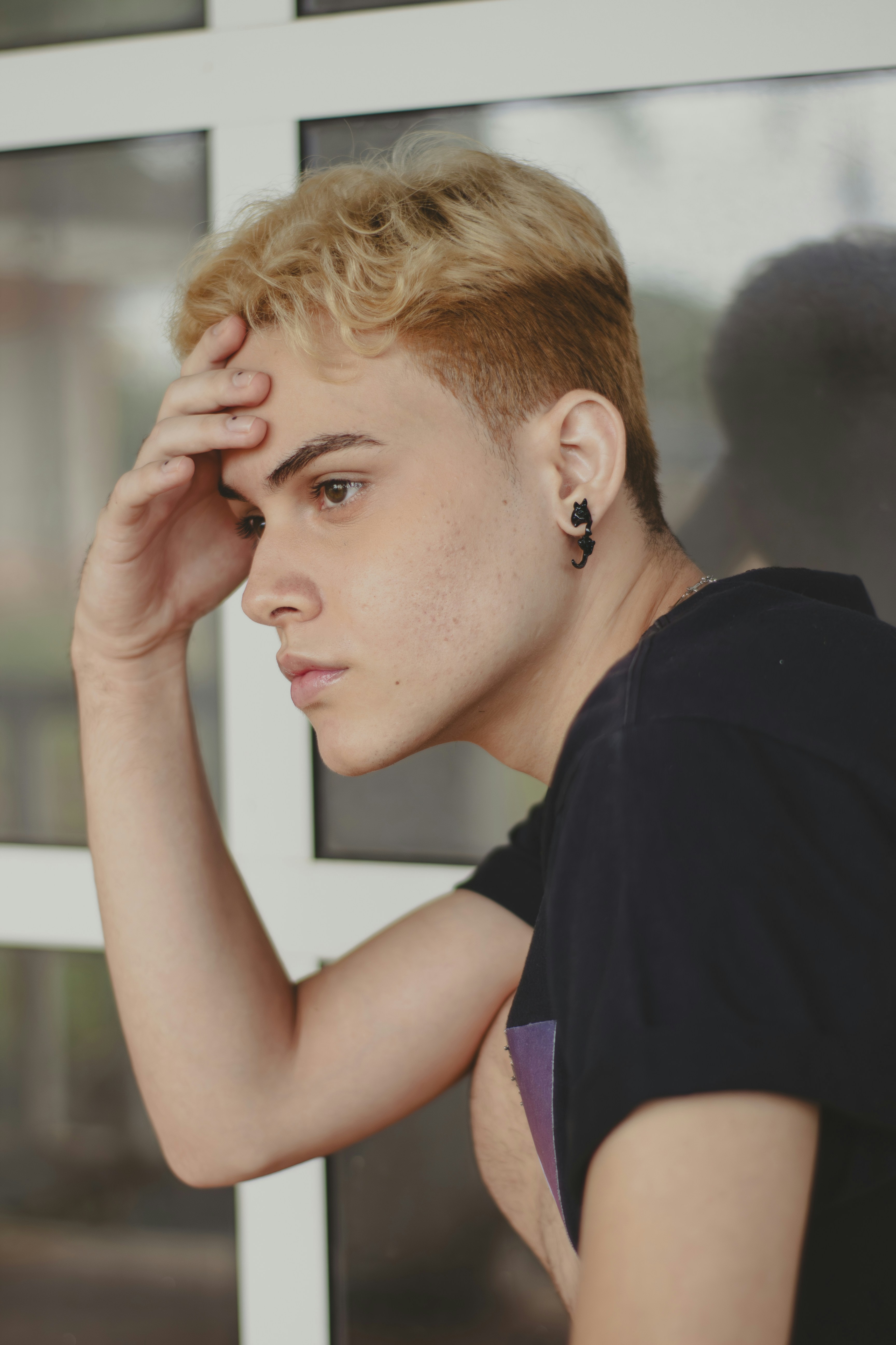 Contemplative Portrait on a Glass-Panelled backdrop