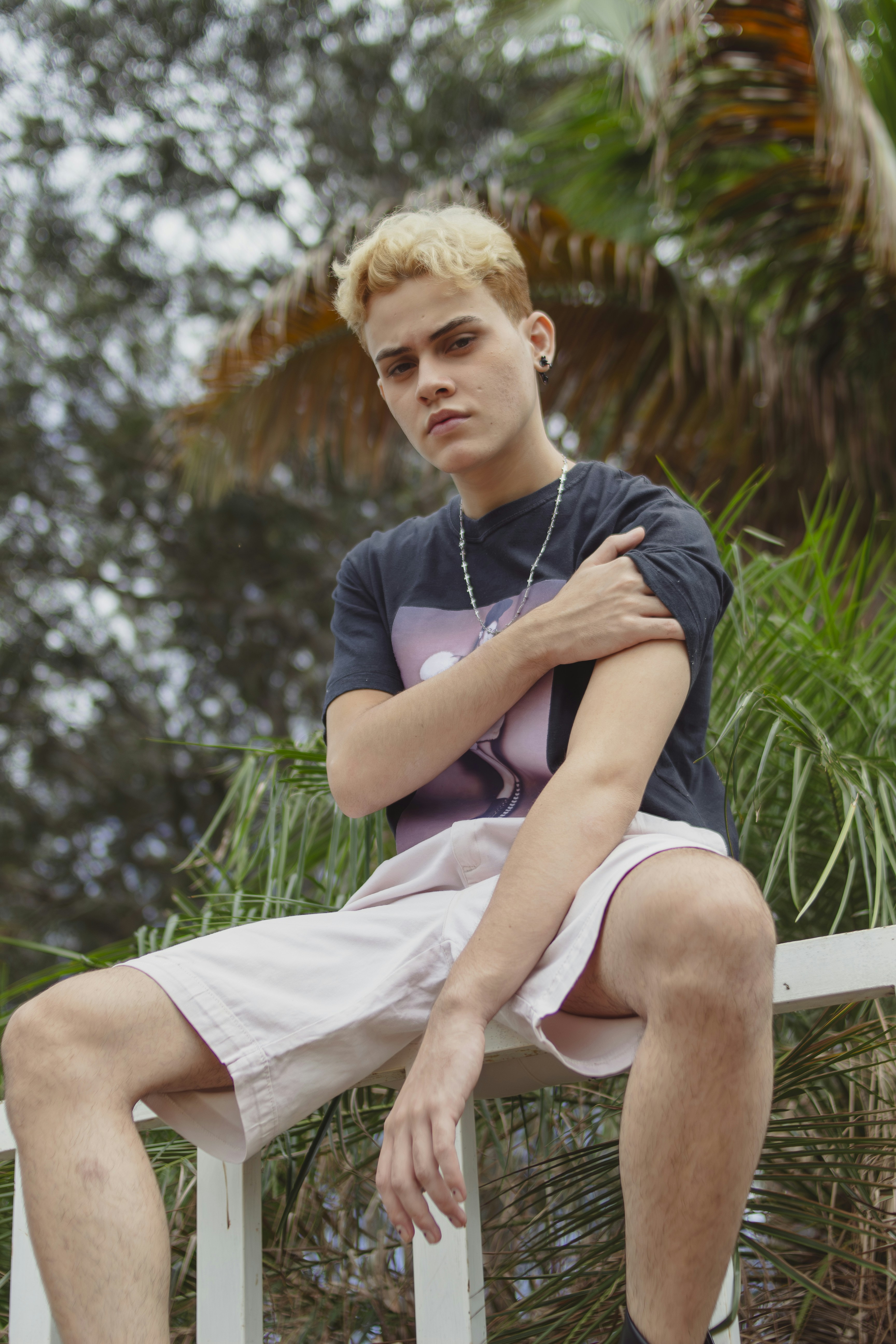 Floating Confidence: Youthful Gaze Amid Tropical Backdrop