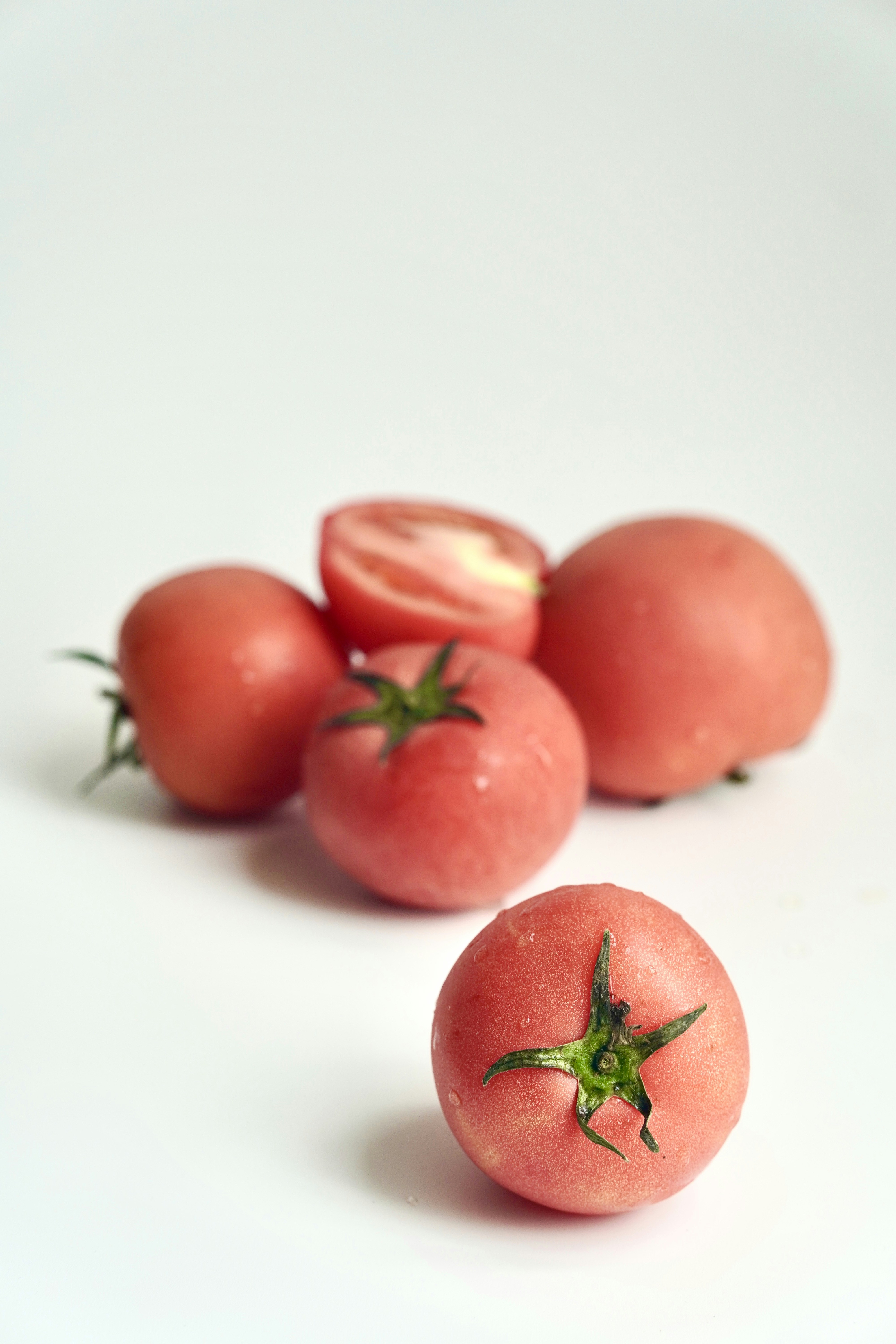 Tomato still life: a cluster with one front-and-center fruit