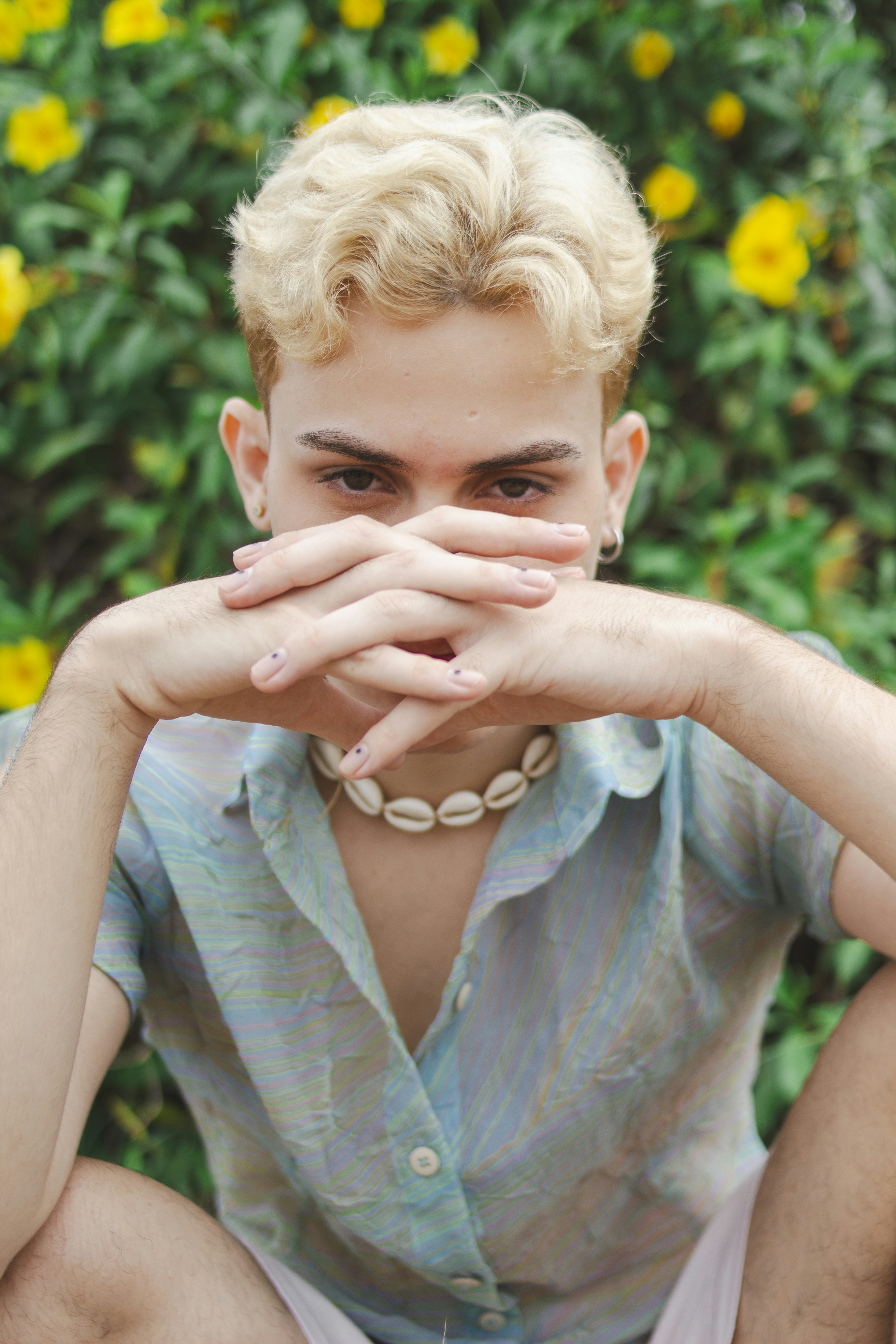 Contemplative Portrait Amid Yellow Blossoms