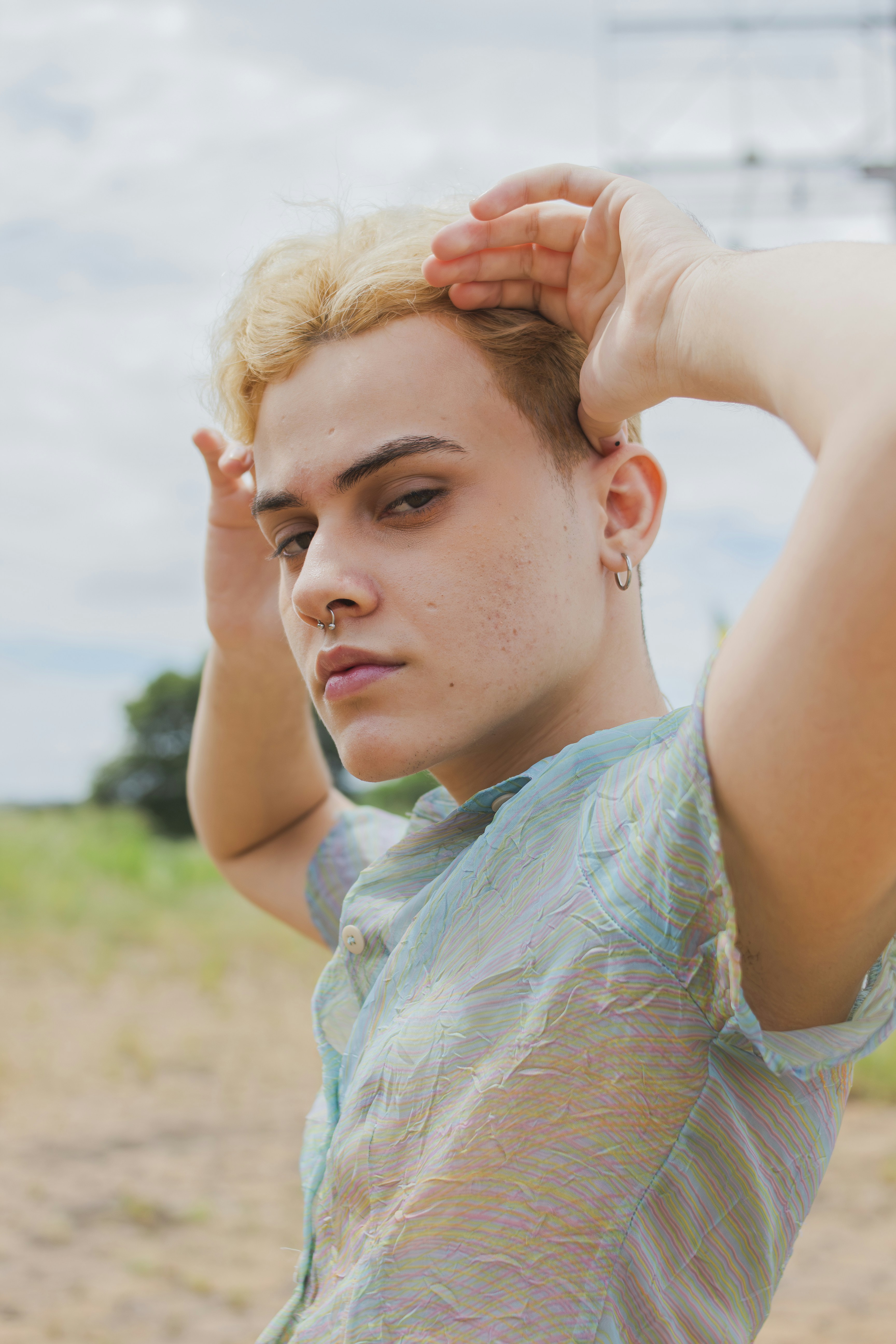 Hands Up, Face Forward: A Portrait in Soft Sunlight