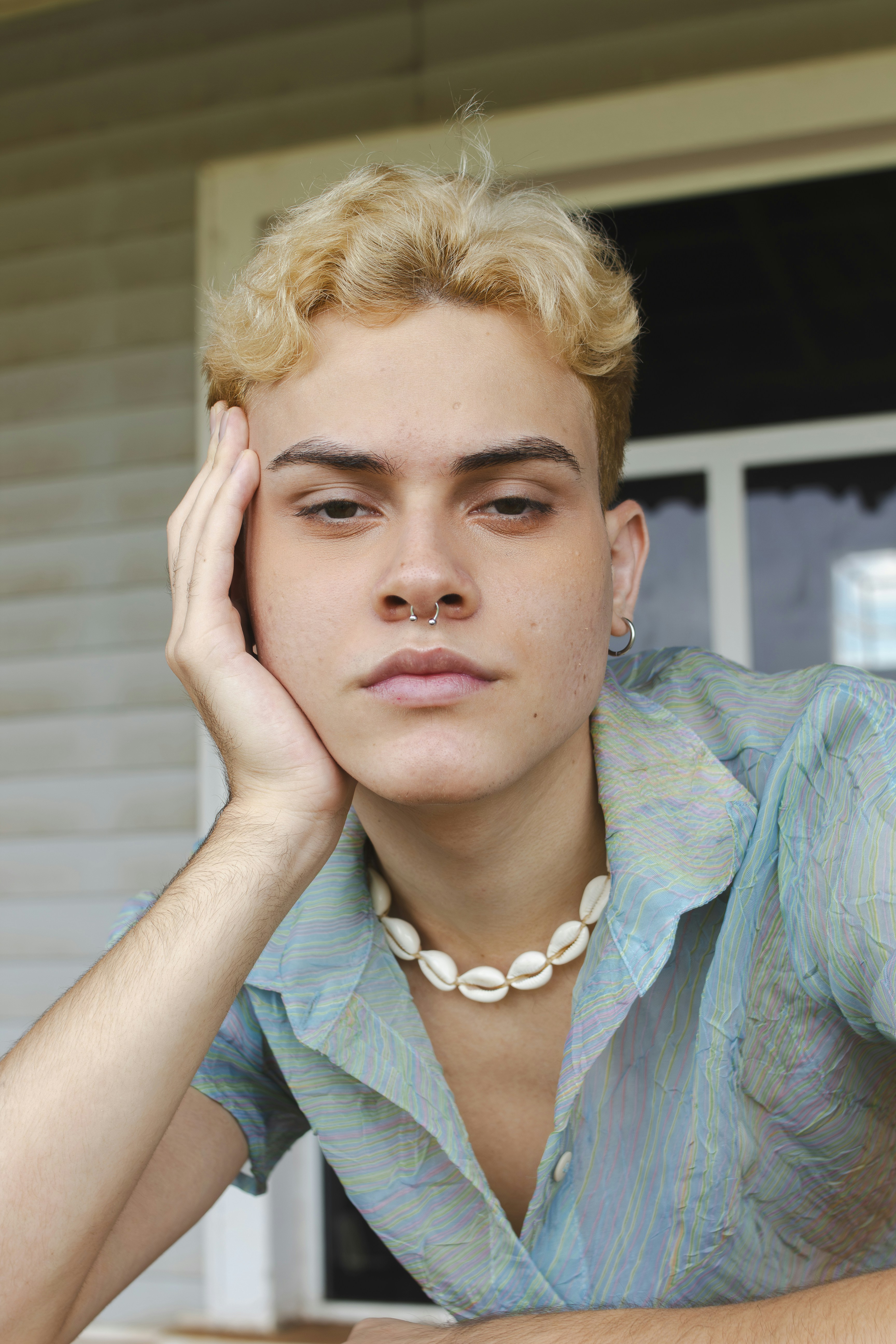 Soft gaze on the porch: a contemplative portrait in pastel tones