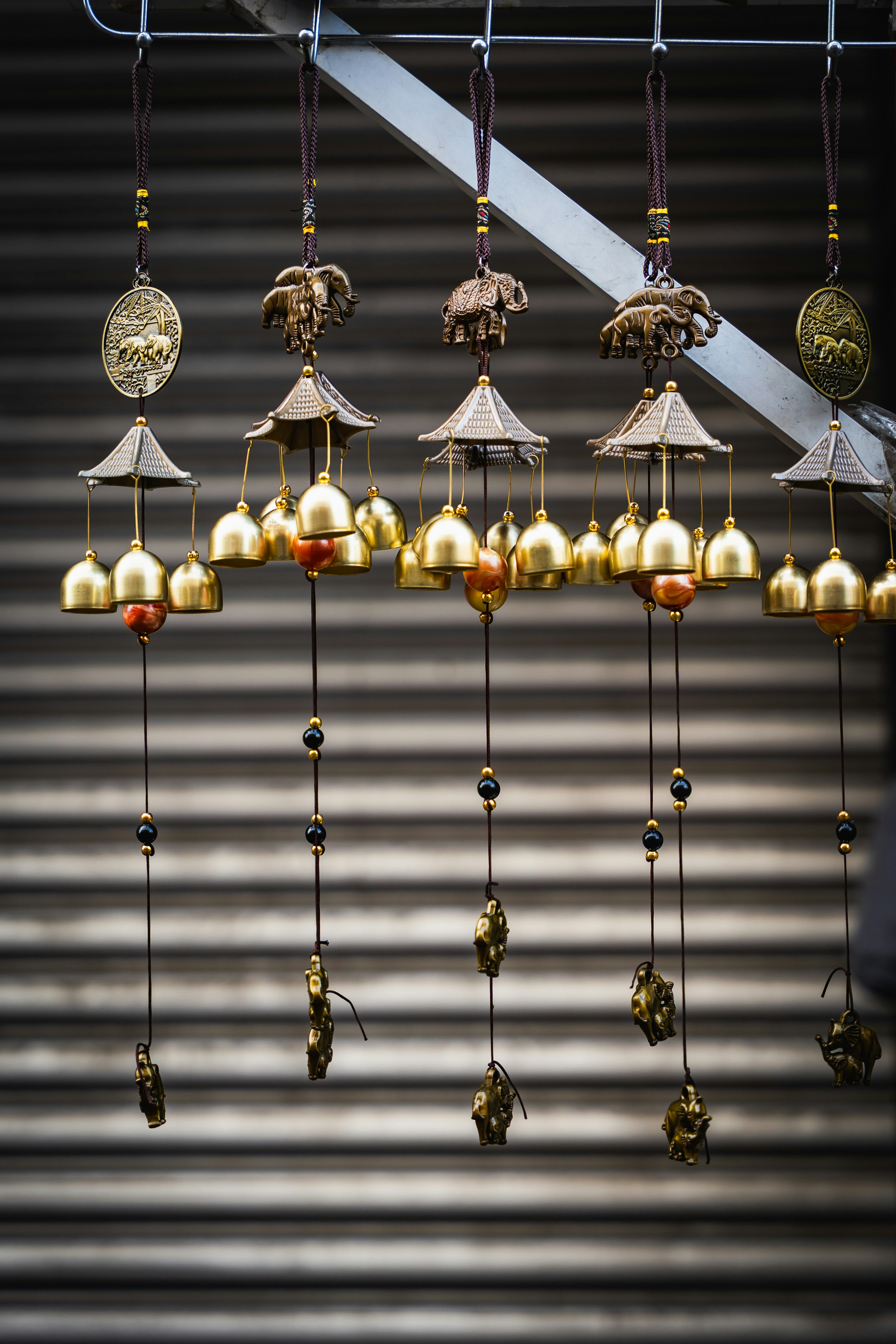 Golden Bells: Windswept Ornaments in a Shuttered Alley