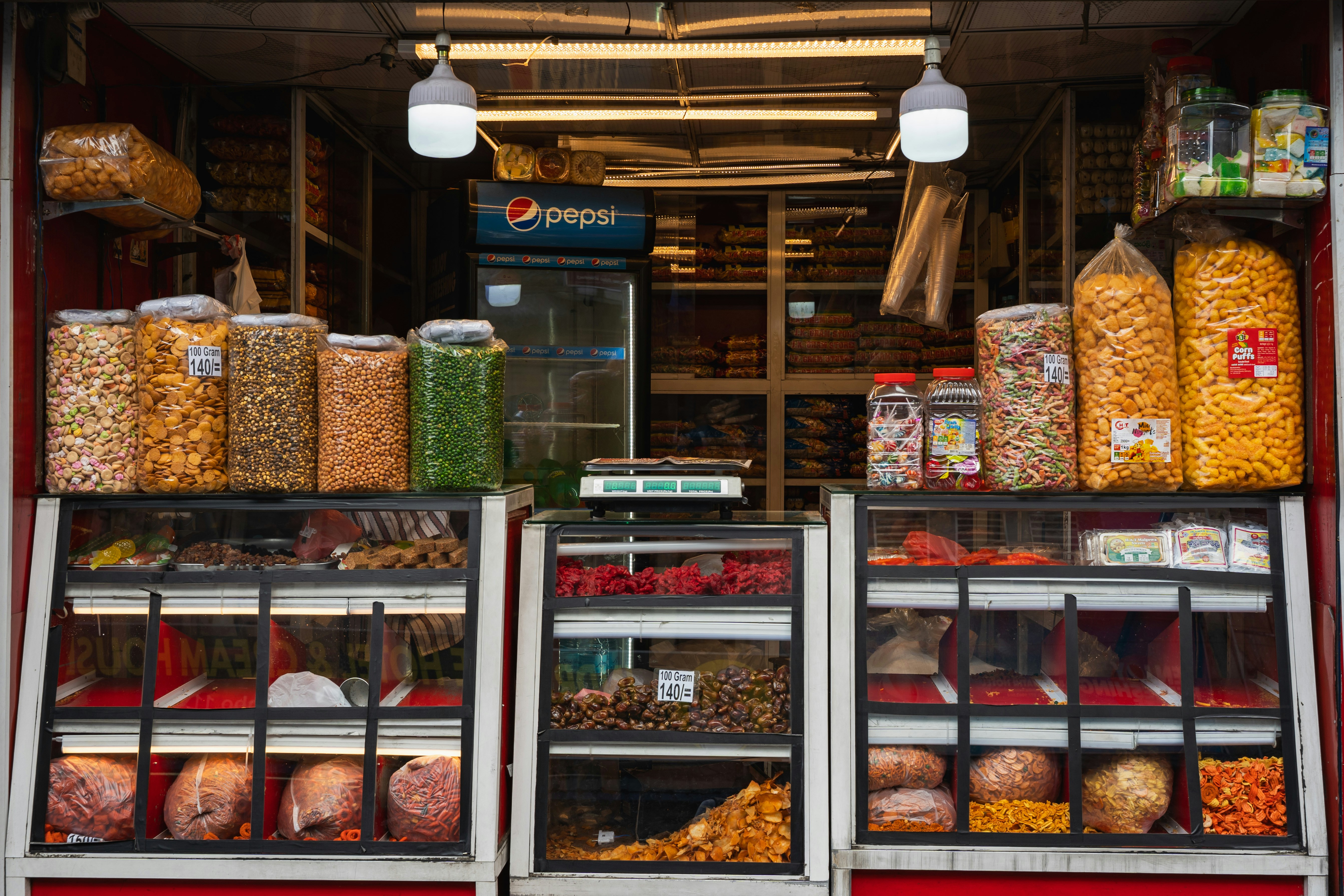 Vibrant Snack Aisle: Glass Display Cabinets Meet Packed Bins