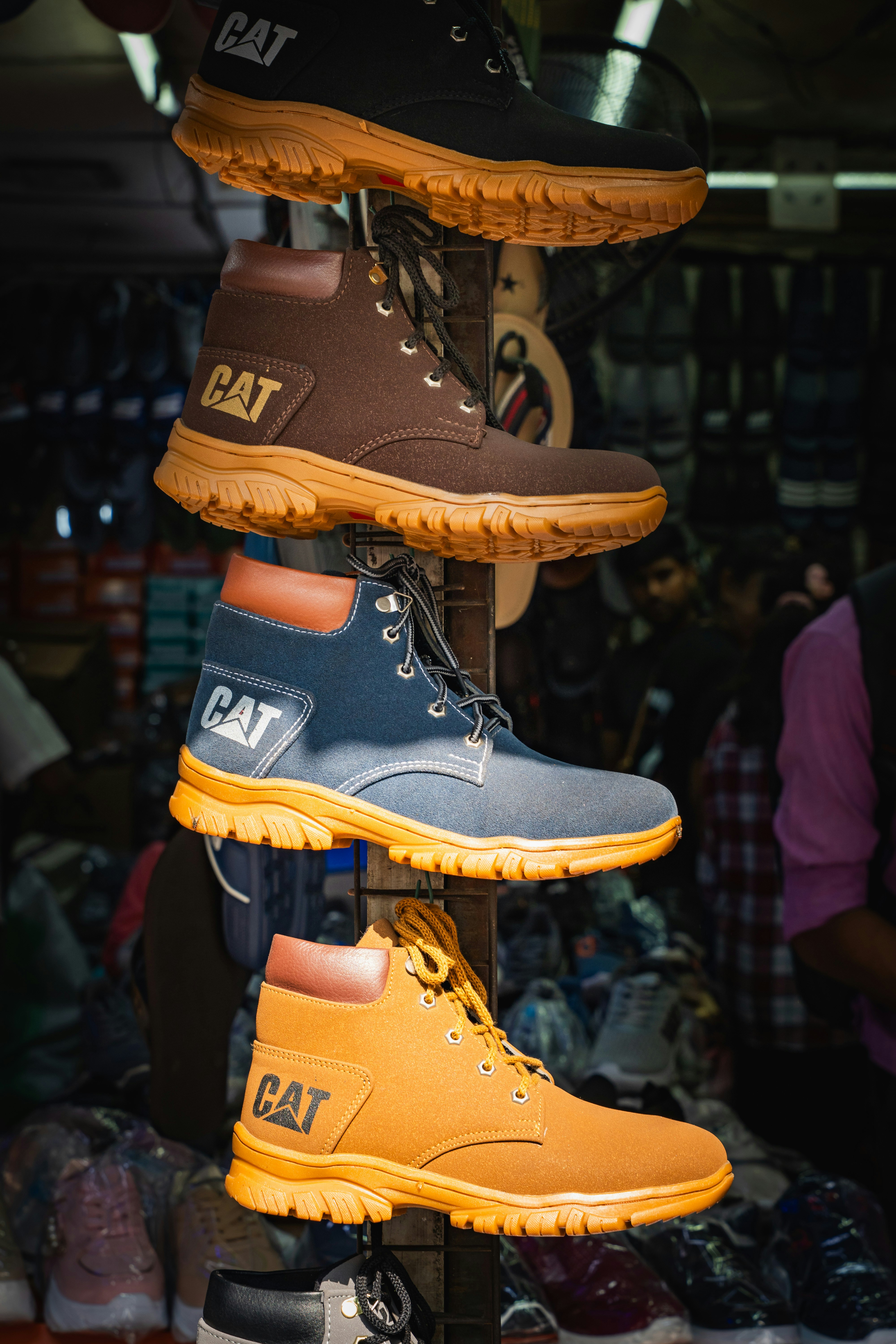 StackedCAT Boots: A vertical display of rugged workwear sneakers