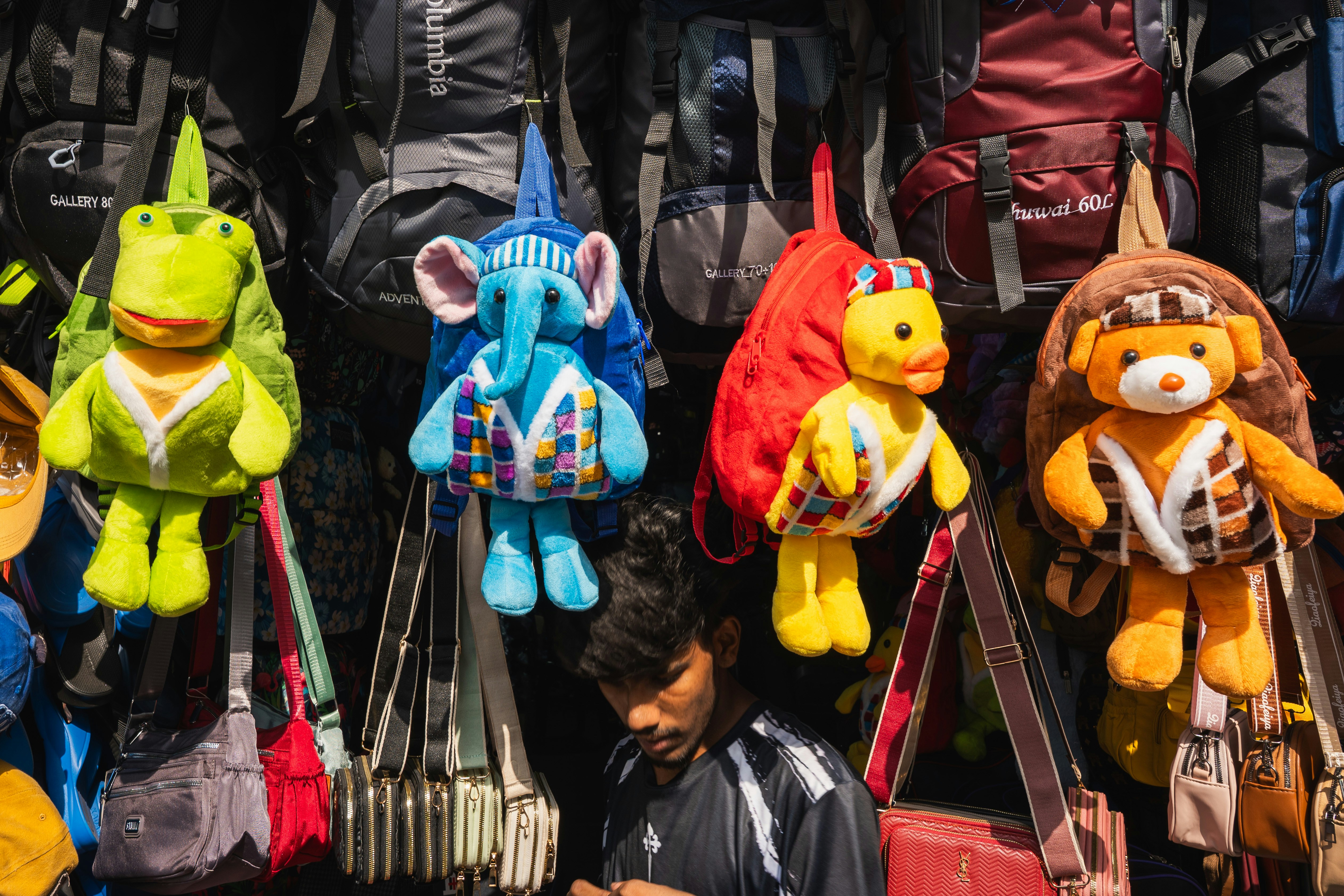 Colorful Plush-Headed Market Stall Under Mixed Light