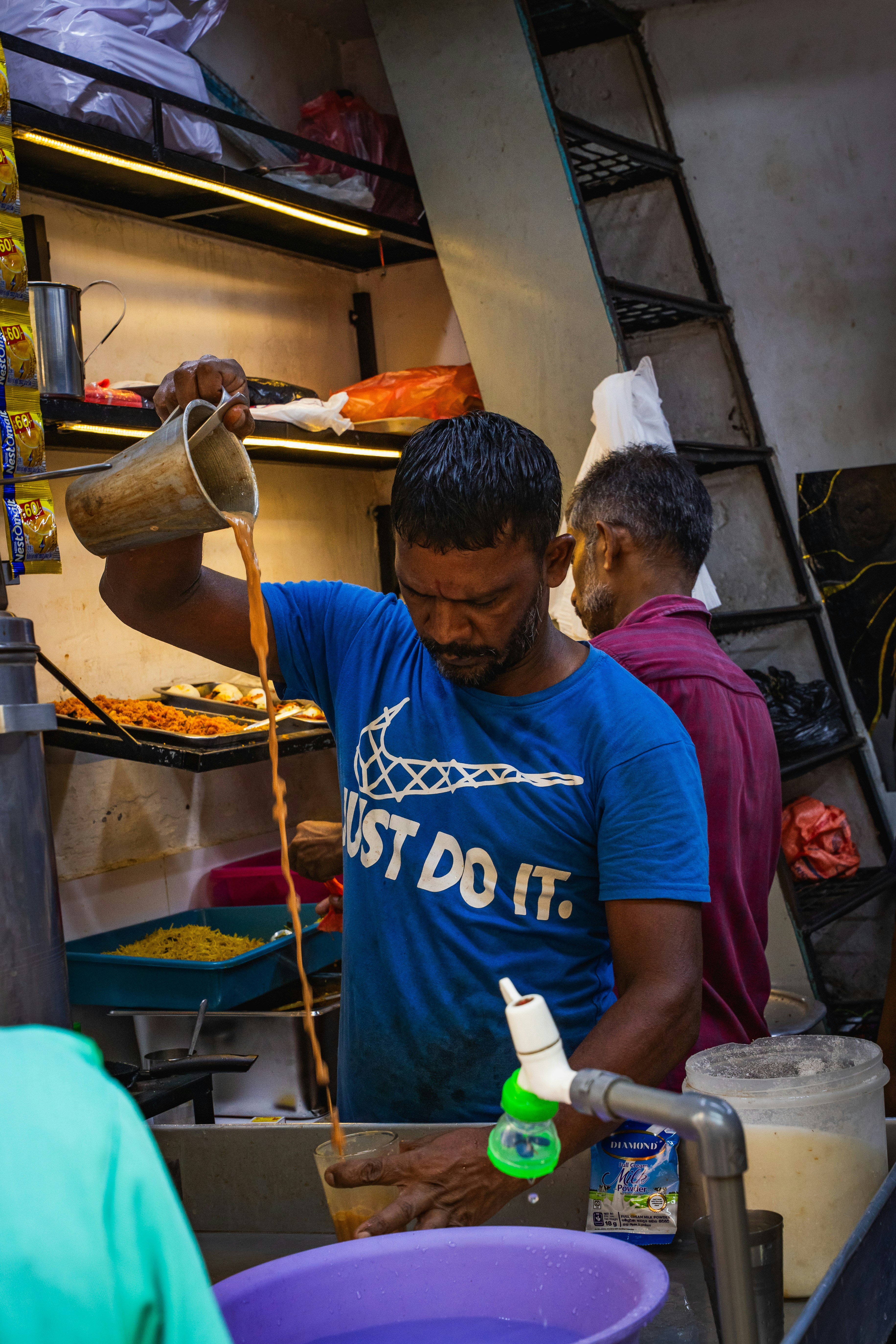 Bright Squeeze: Chef Pouring Sauce in a Busy Street Stall