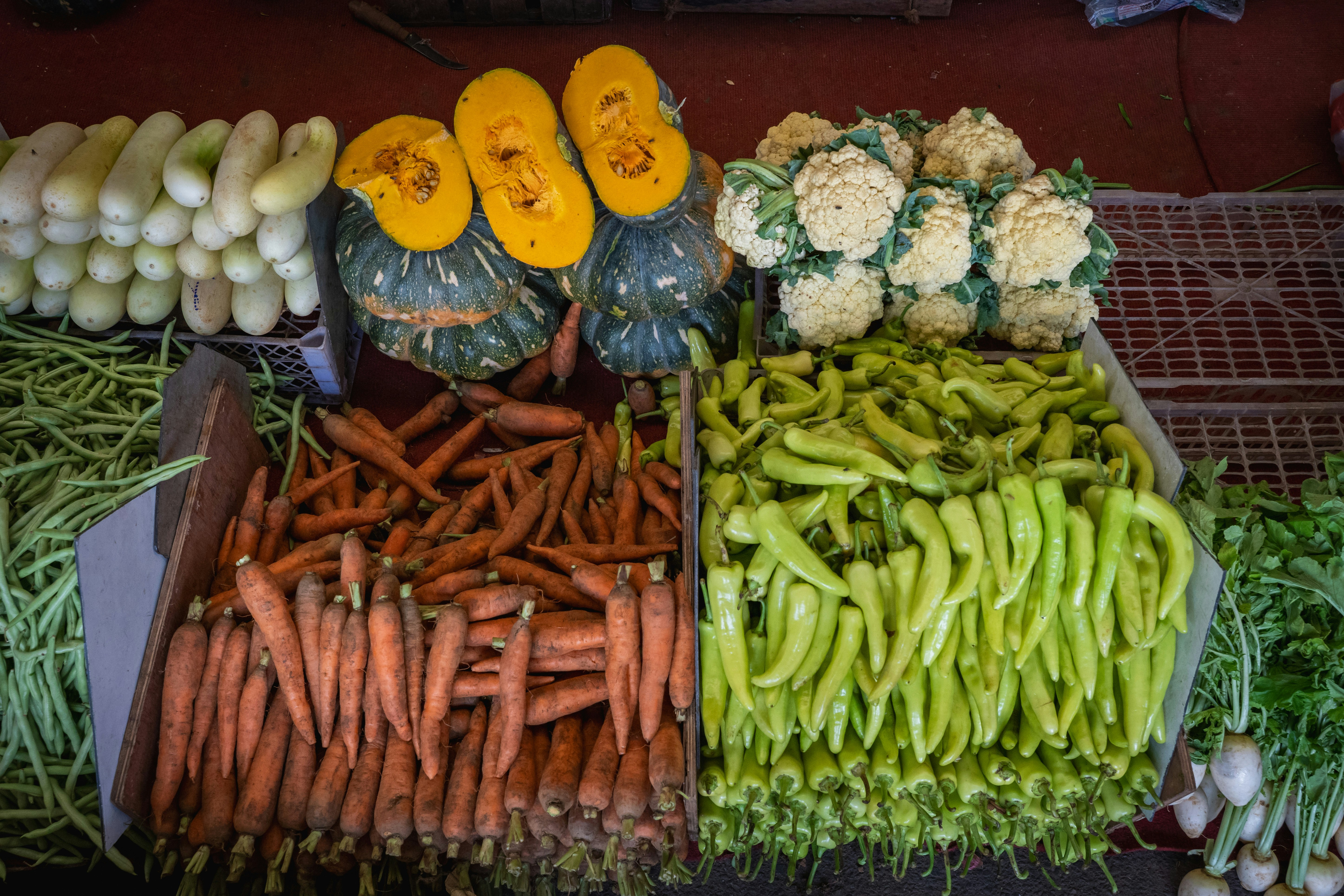 Vibrant Market Bounty: Heirloom Carrots and Colorful Squash Display