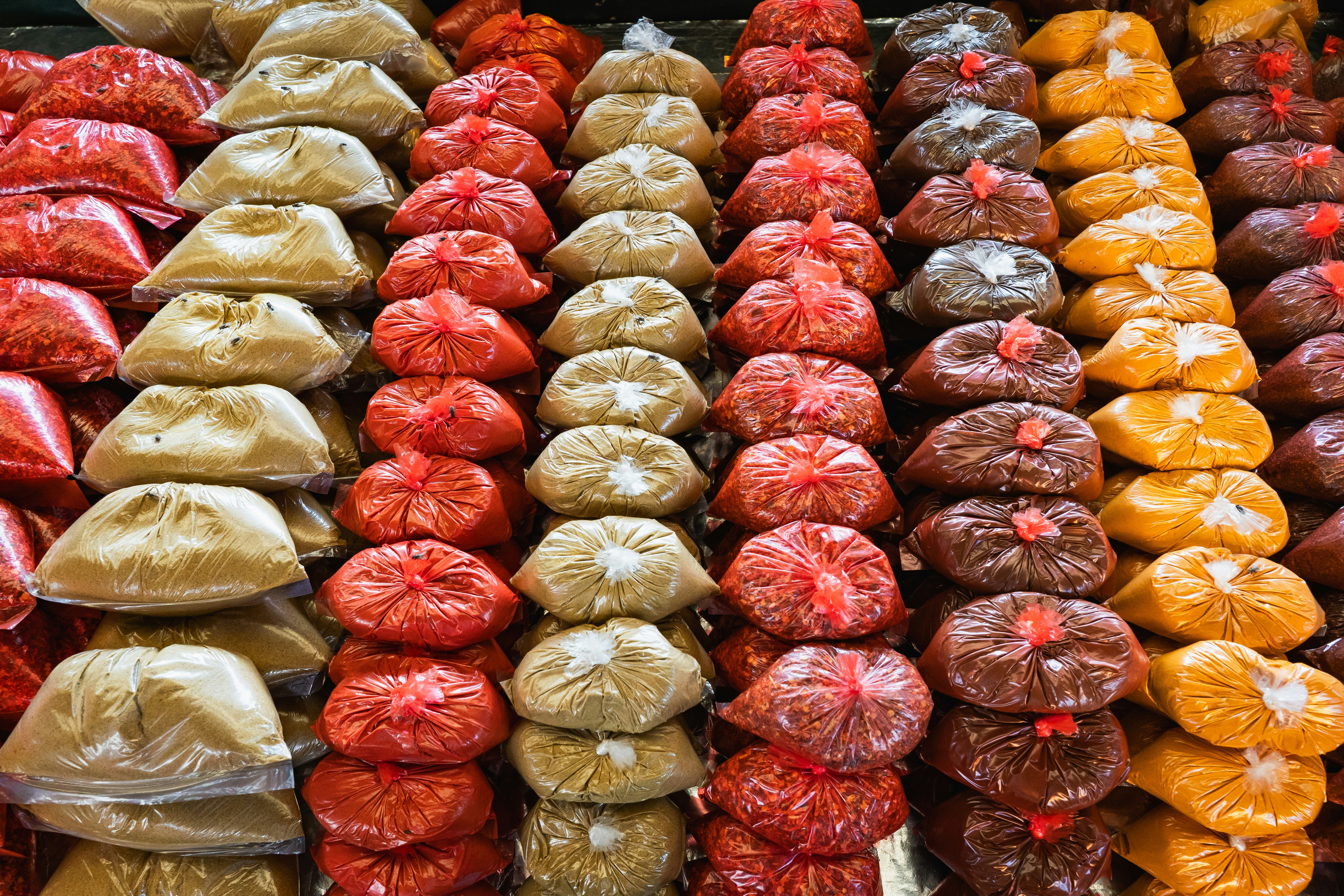 Rows of glossy spice bags create a kaleidoscope of color and texture