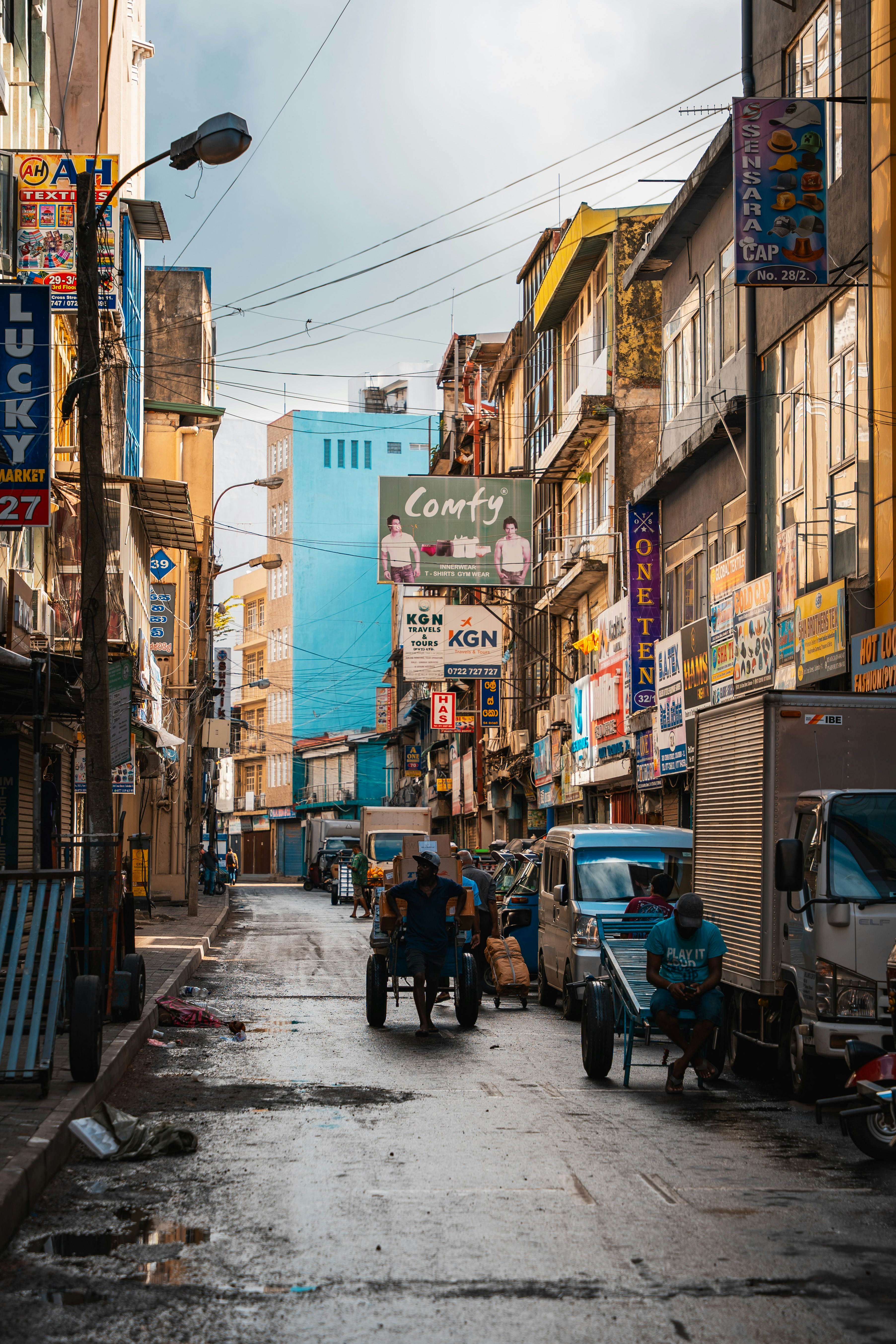 Urban Alleyway Pulse: Midday Traffic Through a Corridor of Signs