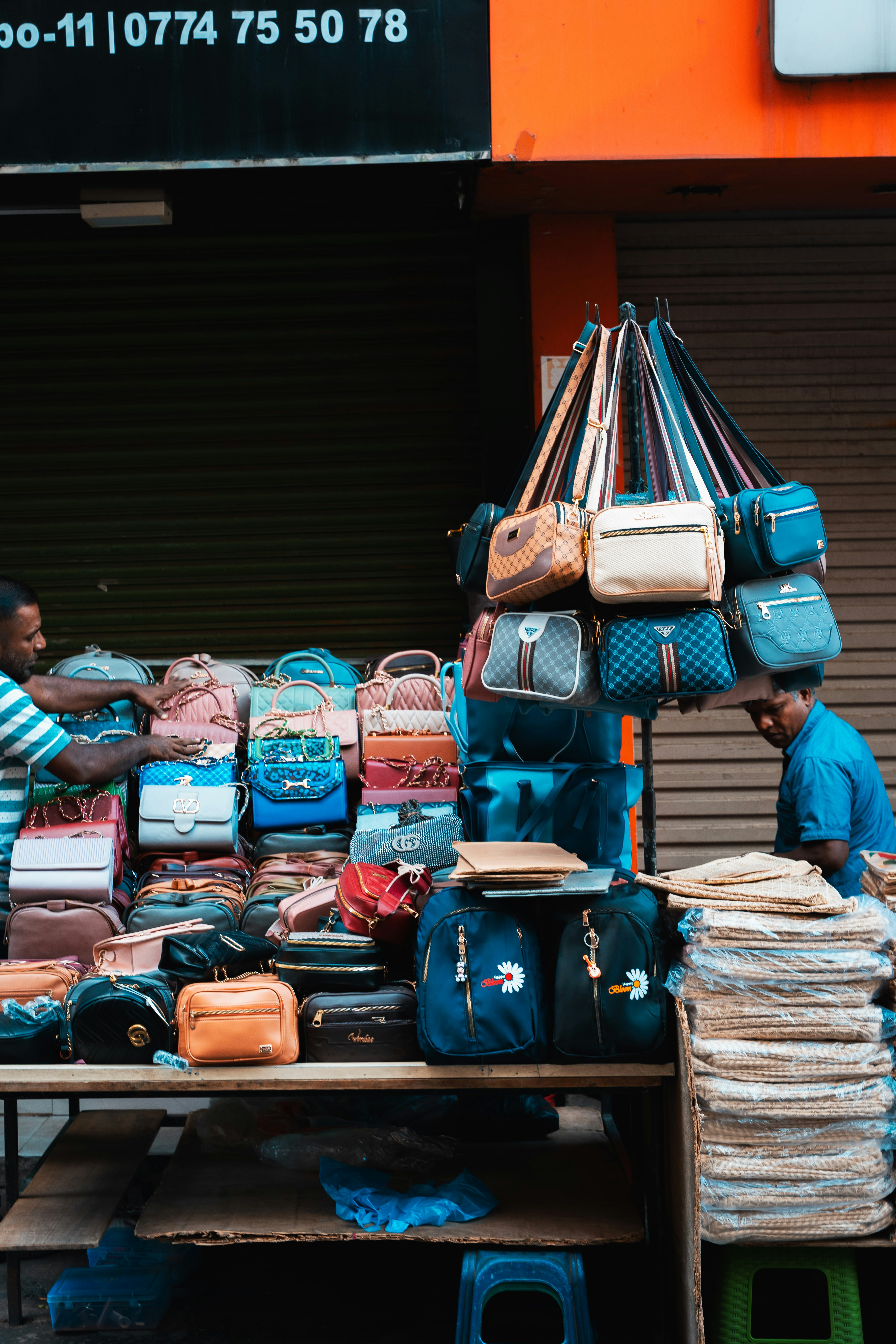 Colorful Backpack Bazaar: A Street Corner Display of Handbags