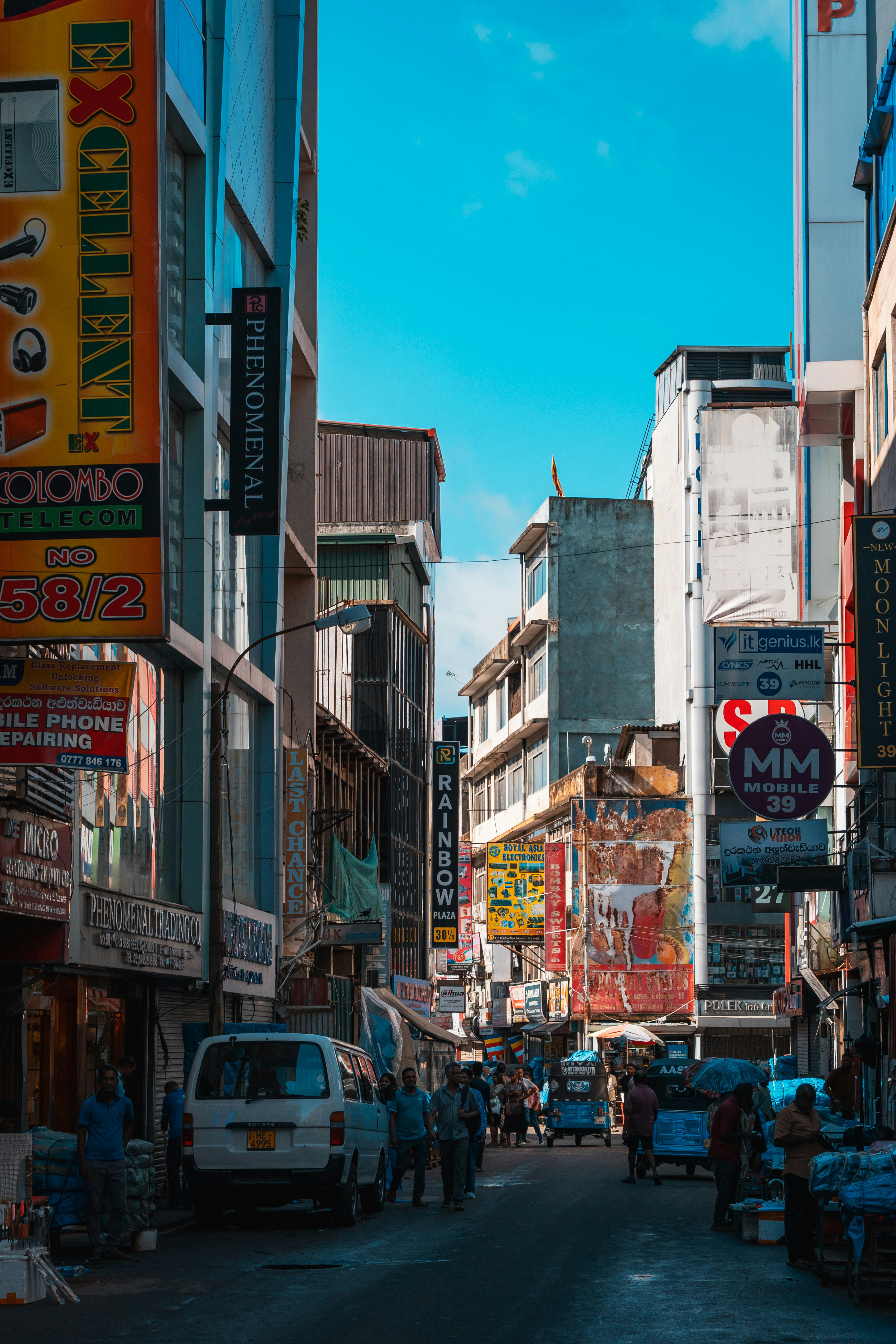 City Corridor: Signboards, Shops, and a Sunlit Street