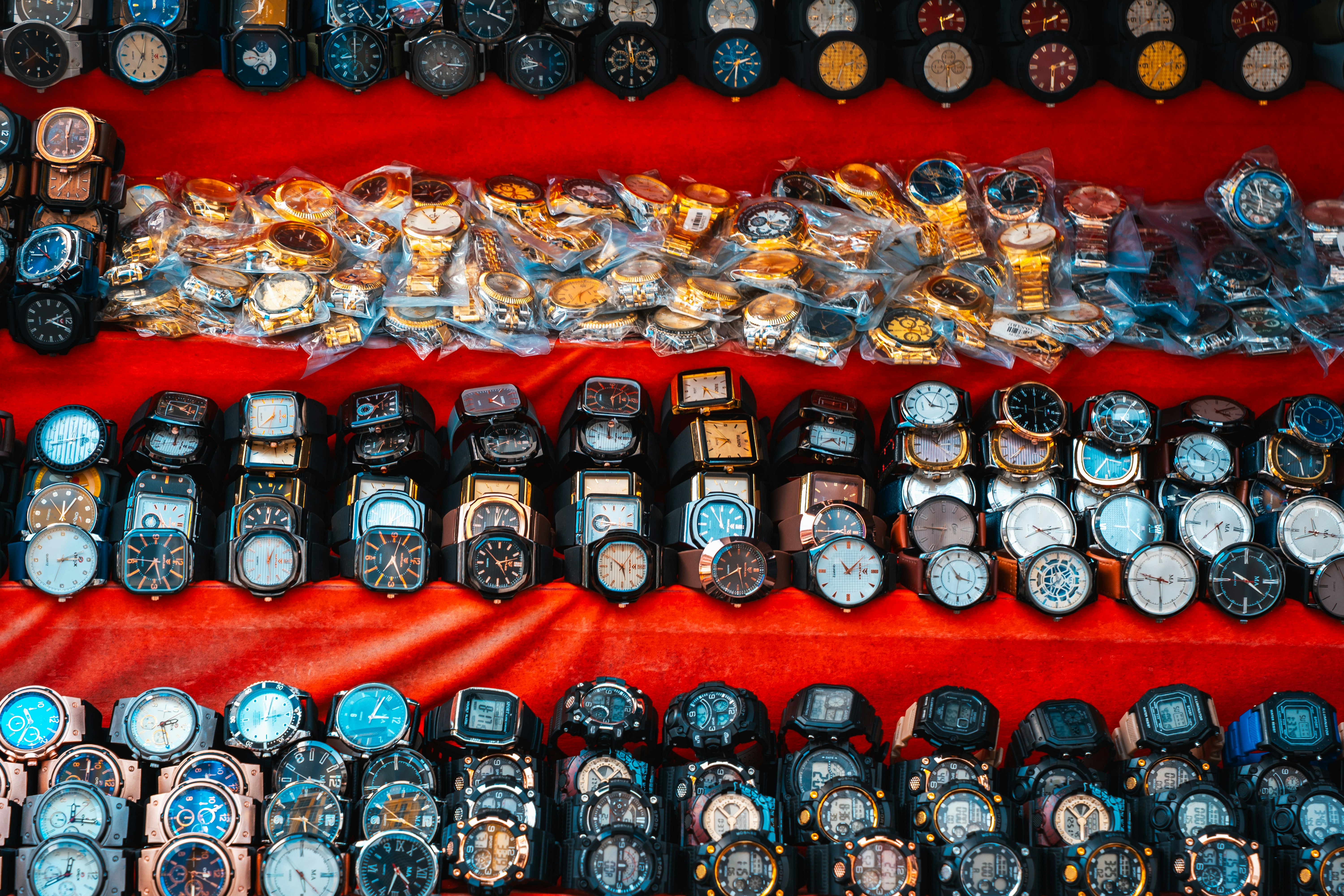 A Sea of Timepieces: Colorful Watch Row Faces in a Crafts Market