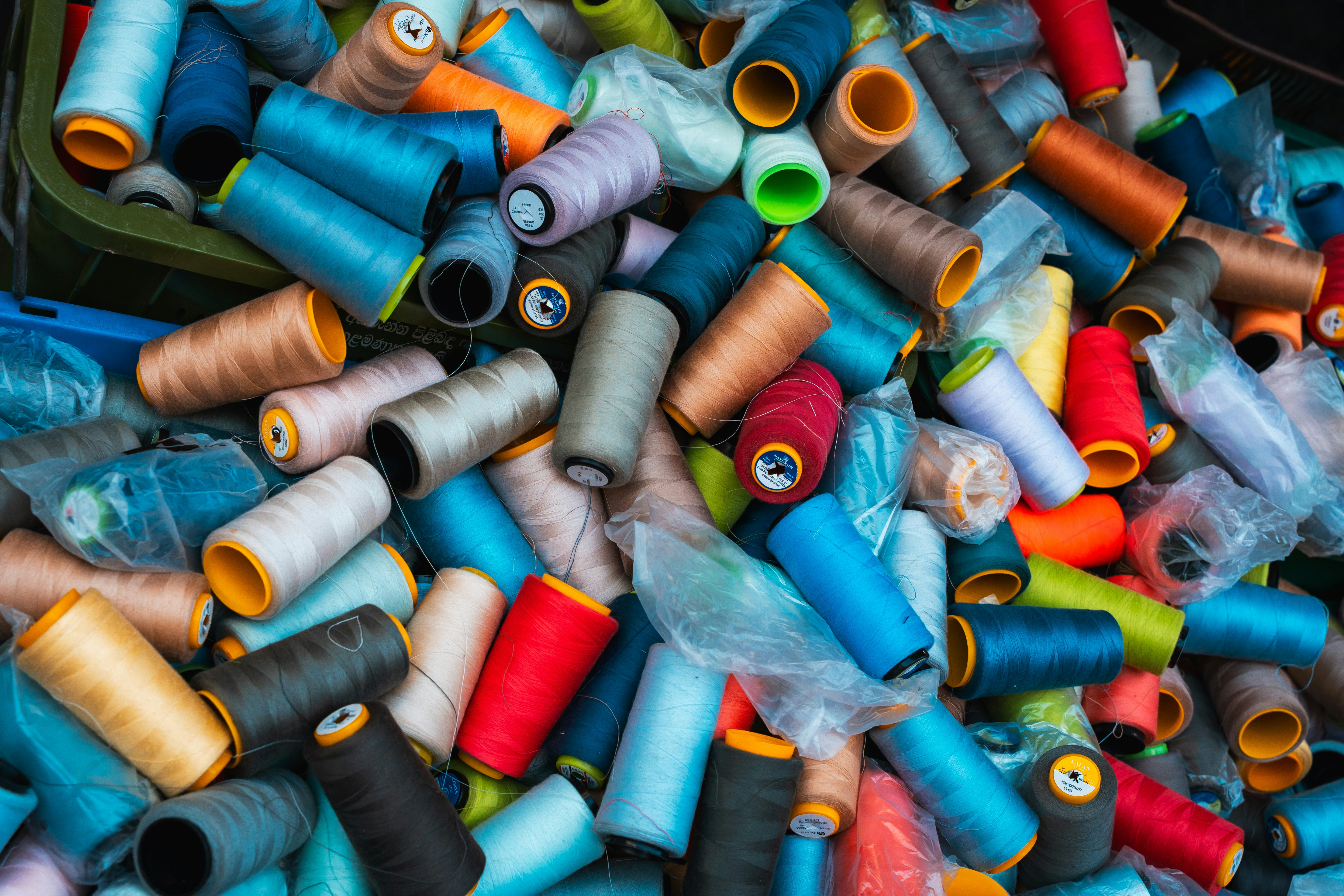 A Tangled Palette of Threads: Colorful Bobbins in a Tubular Sea