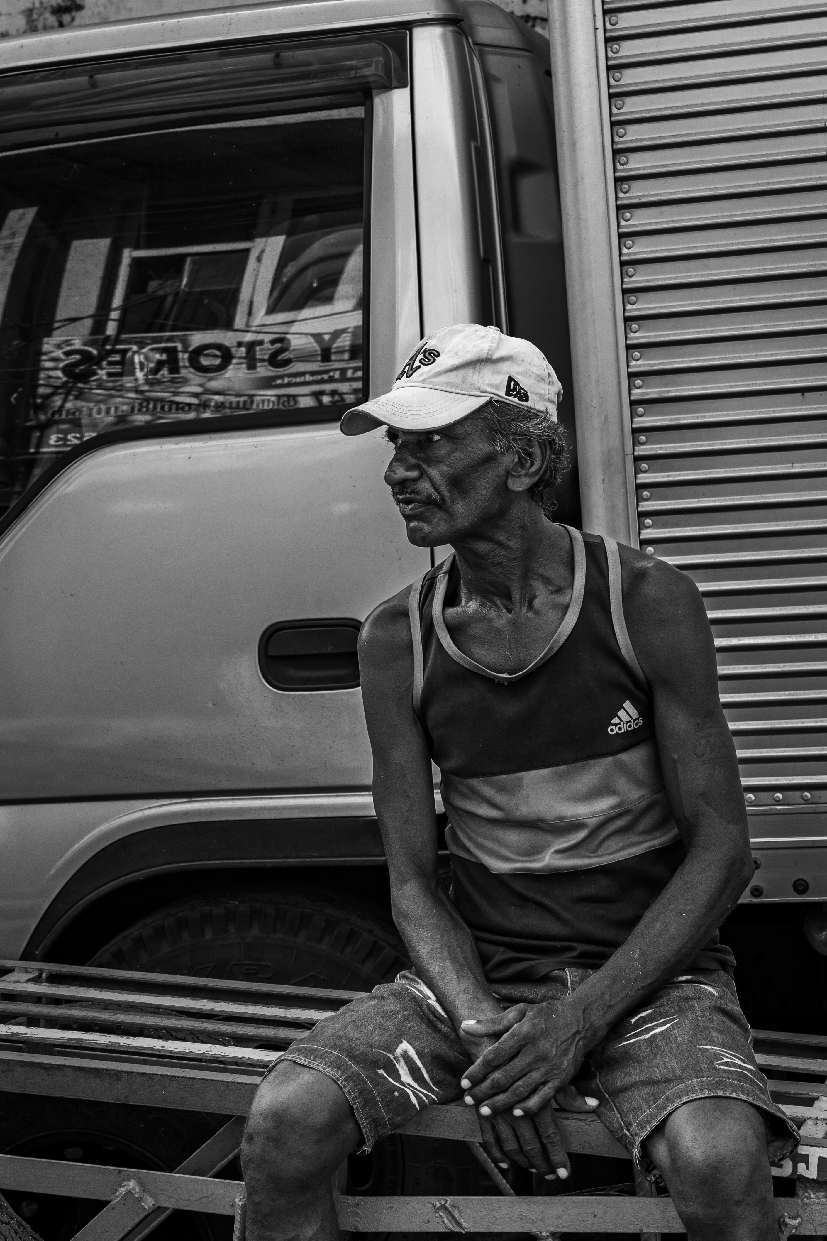 Street Portrait in Black and White: Quiet Strength by the Trailer