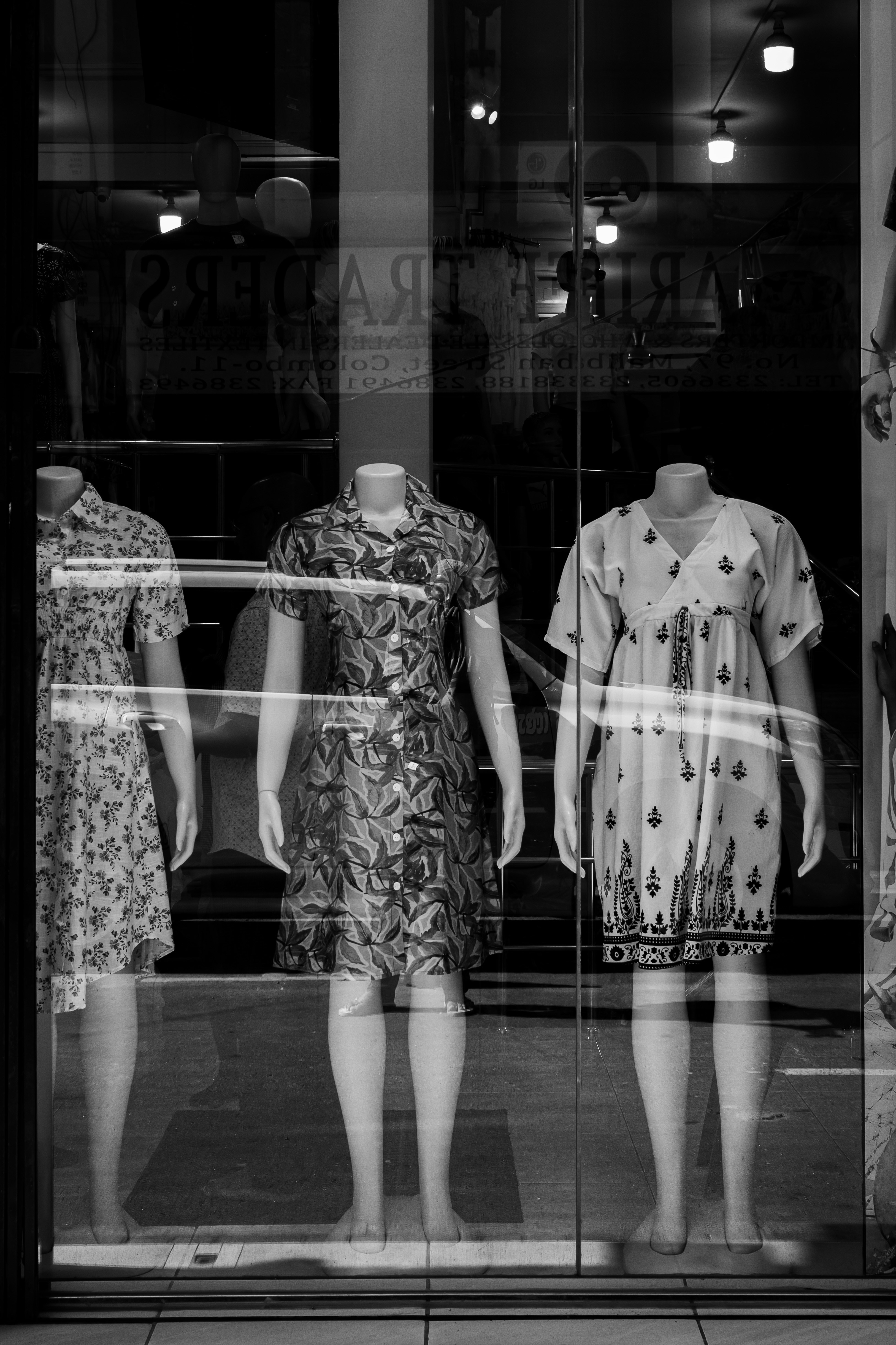Three Monochrome Dressed Silhouettes in a Shop Window