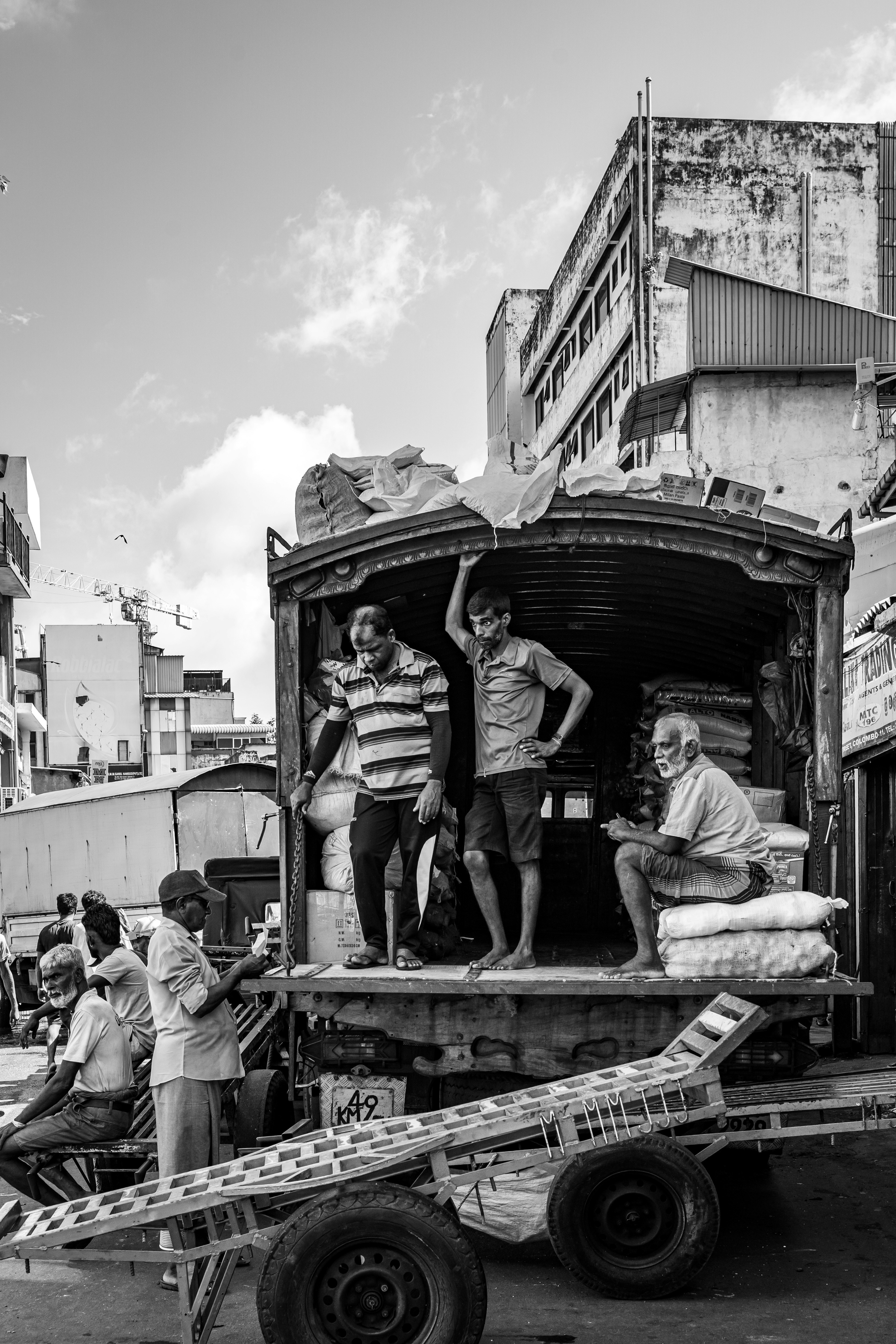 Emptying the Load: Men at the Dented Truck Dock
