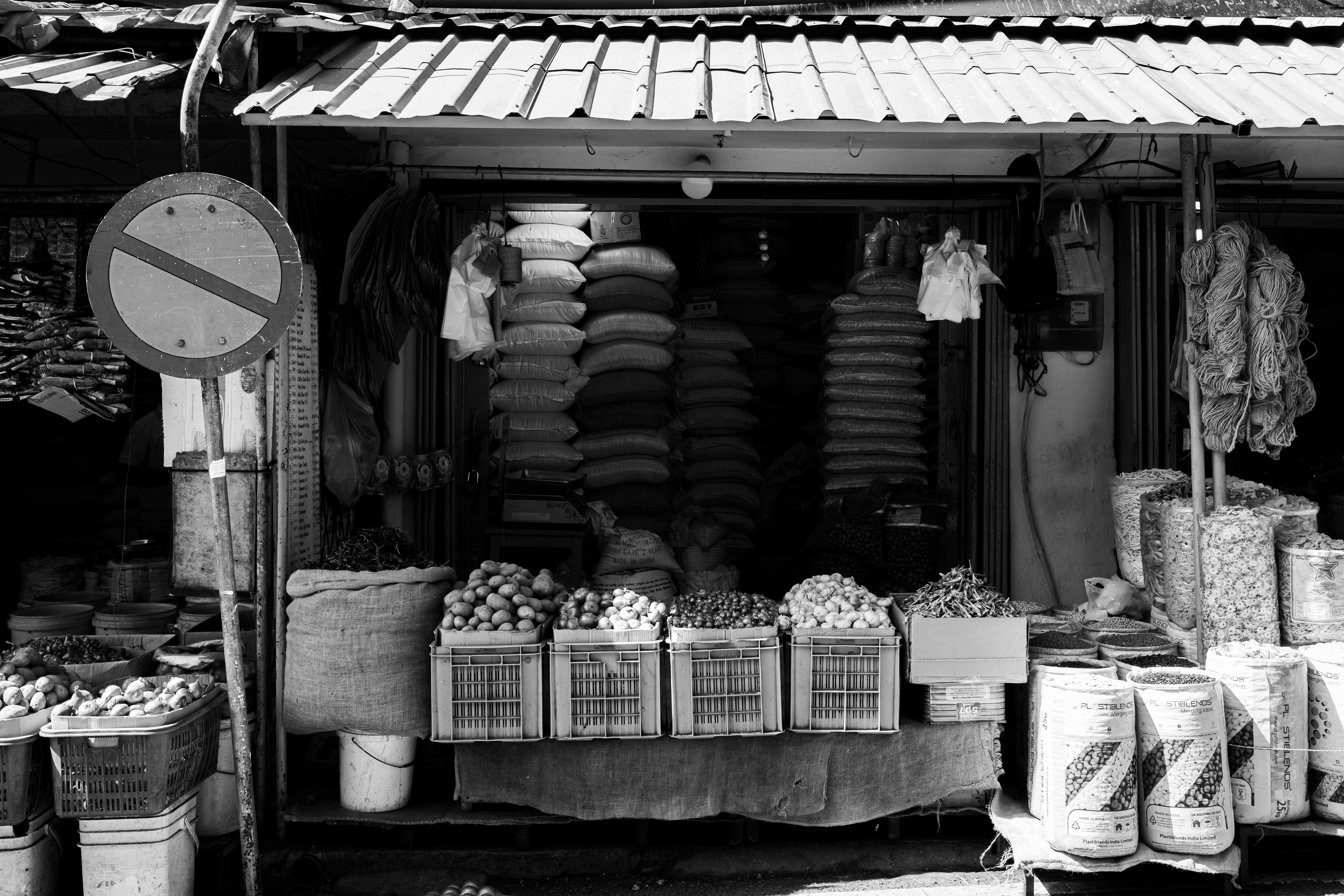 Market Stall in Monochrome: Stacked Goods and Goods in Baskets