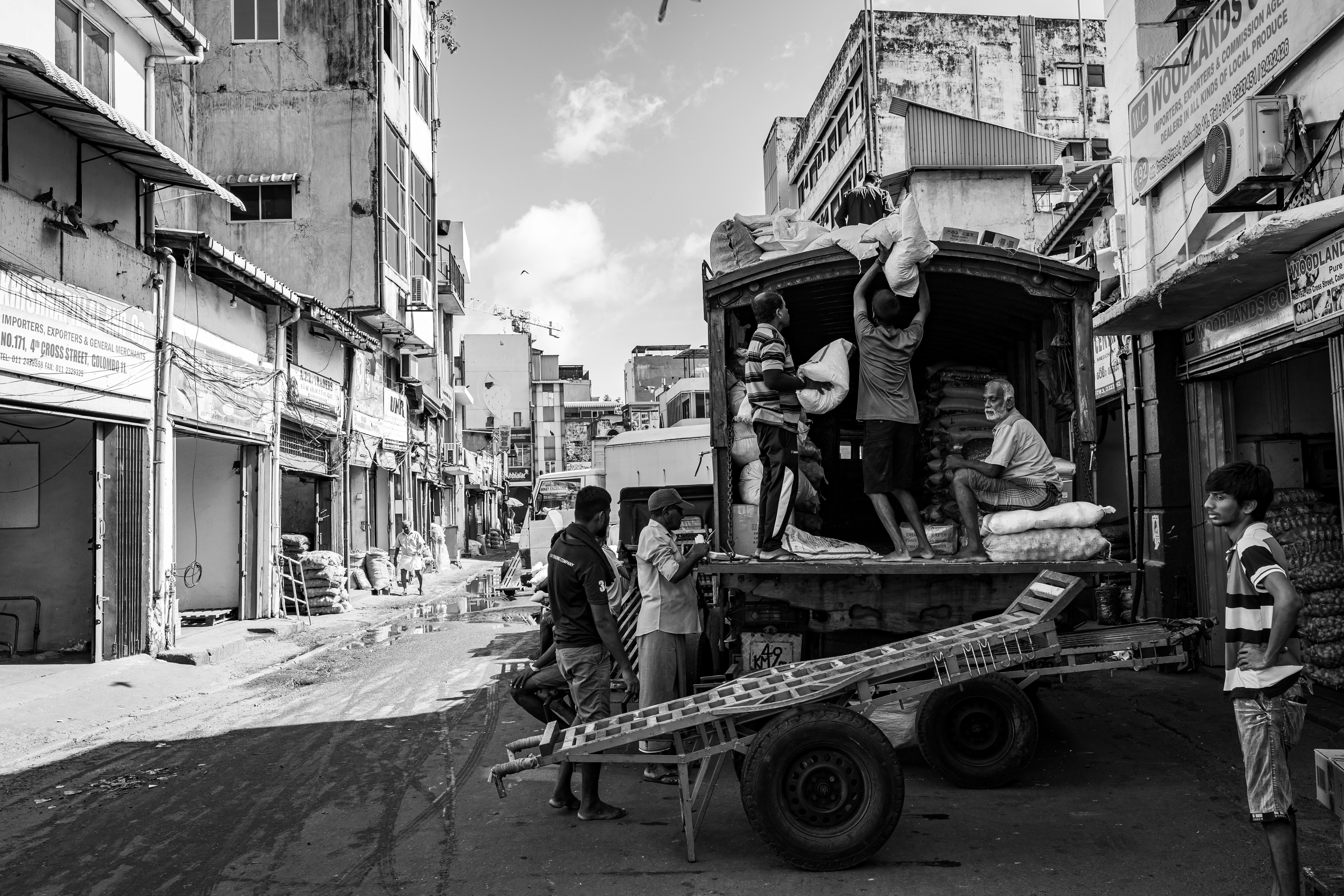 Toward the Cart: Street Vendors and a Loading Operation in Black-and-White