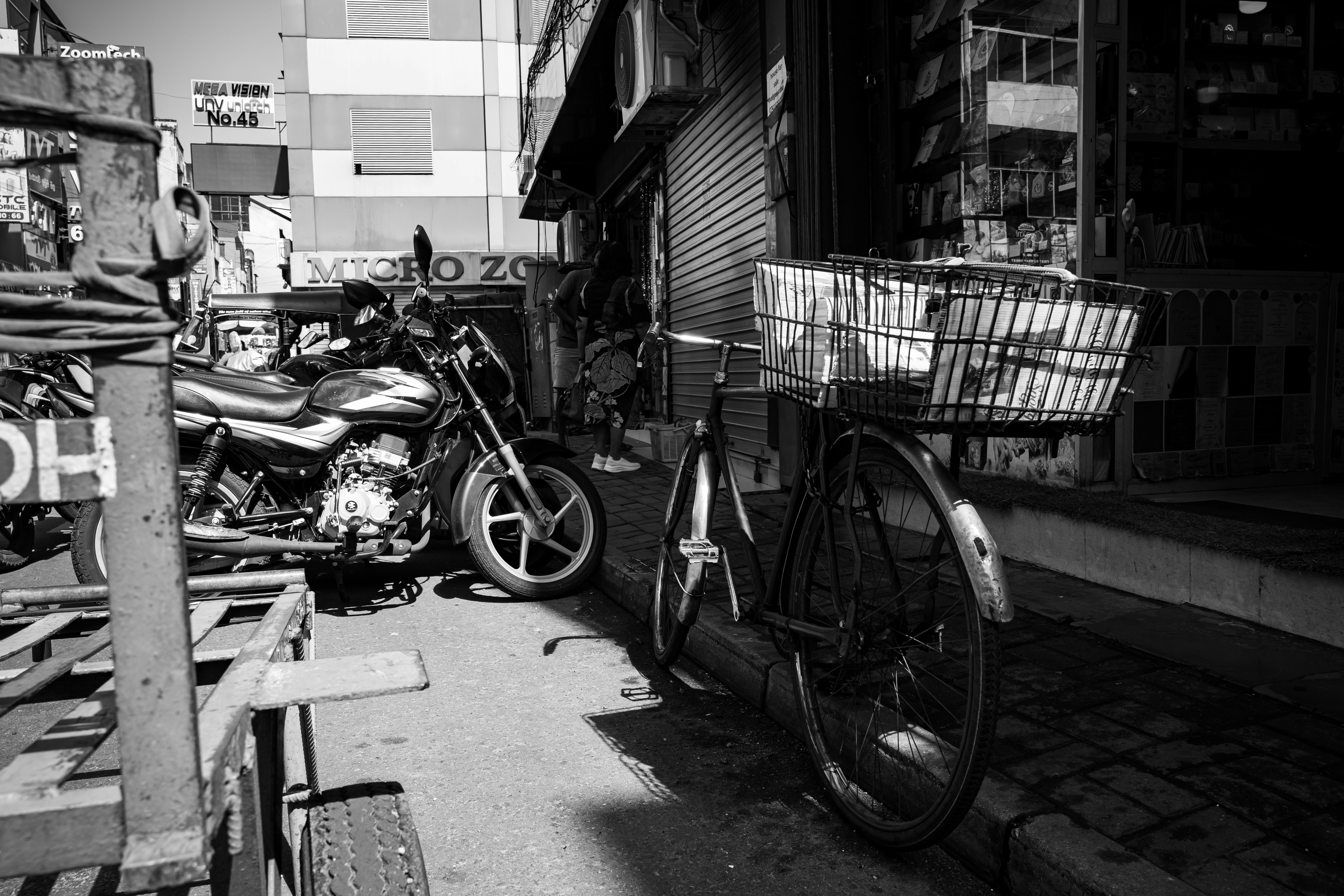 Streetside Storage: A Quiet Clash of Pedals and Frames
