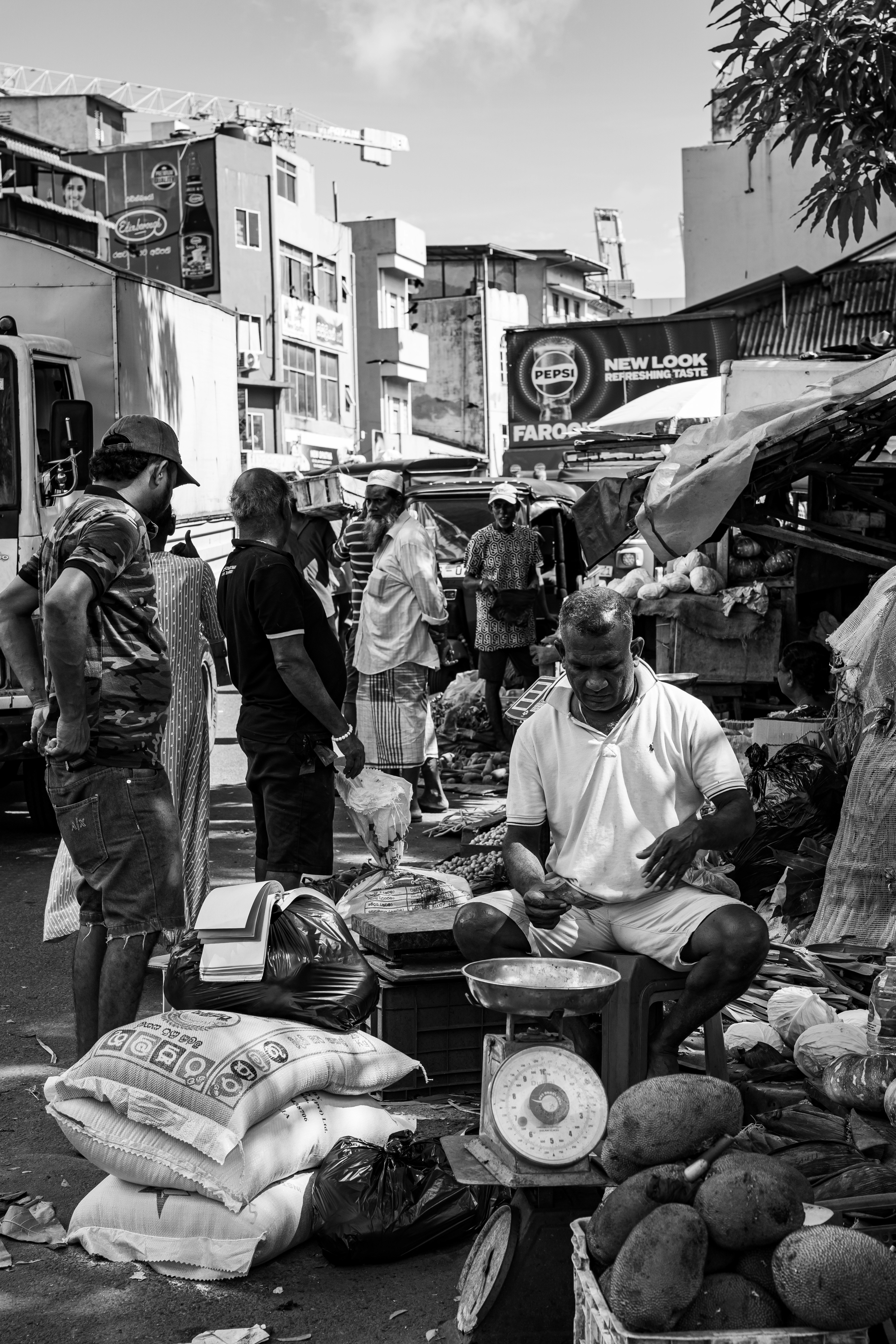 Street Market Moment: The Vendor and Scales Amid Everyday Trade