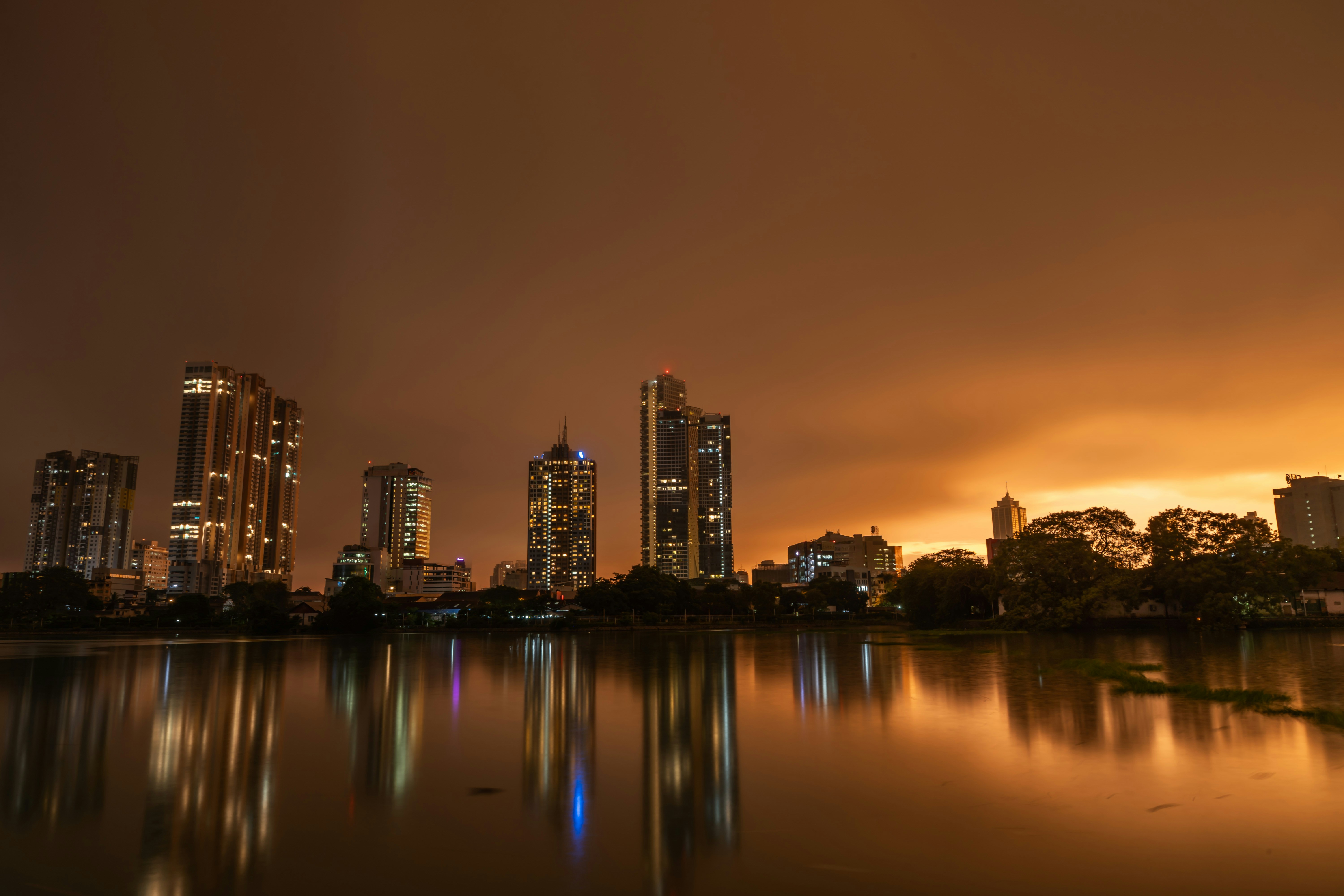Midnight Skyline: Golden Clouds Reflected on Quiet Waterfront