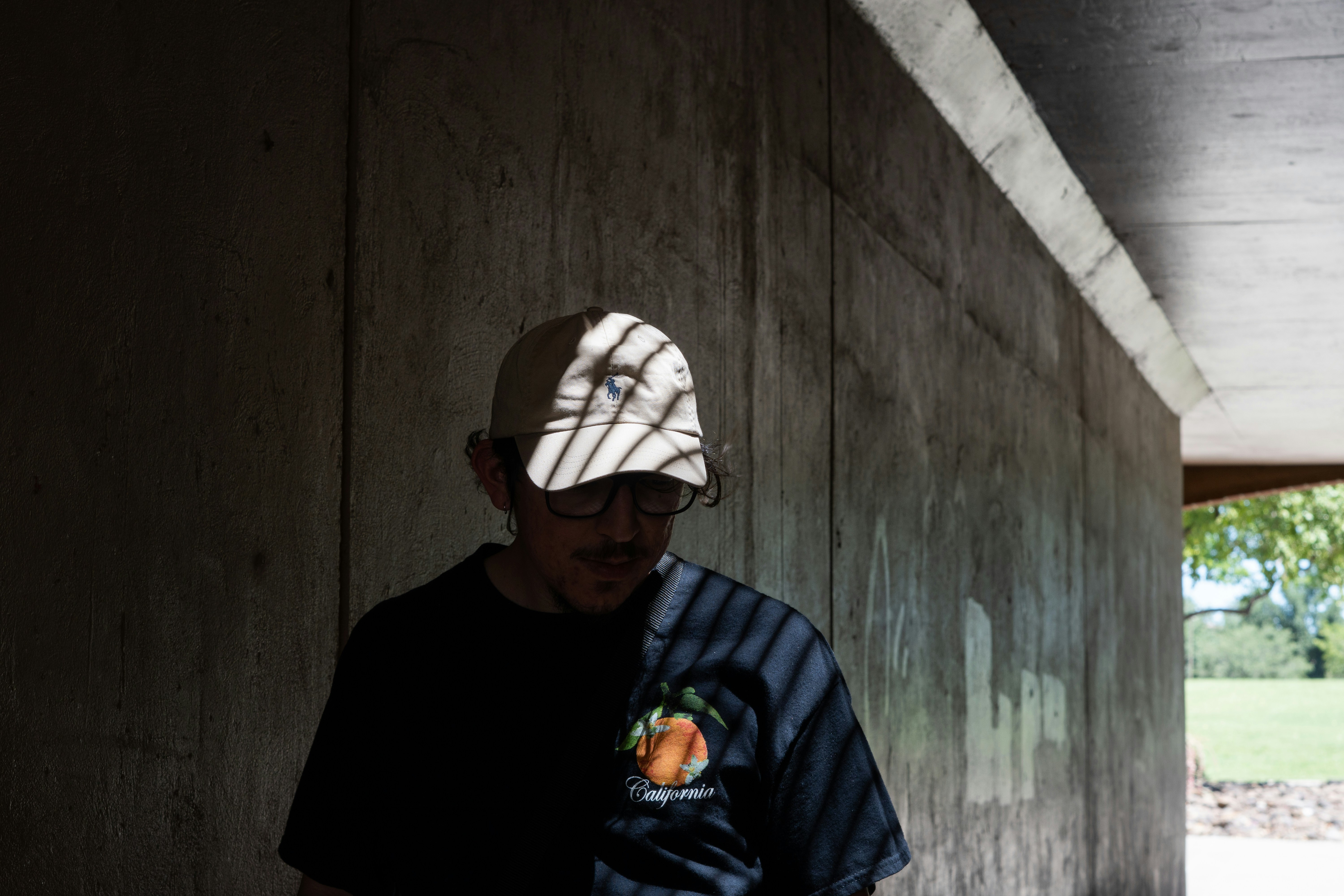 Hidden Light Under the Overpass: Portrait in Shadow and Smile
