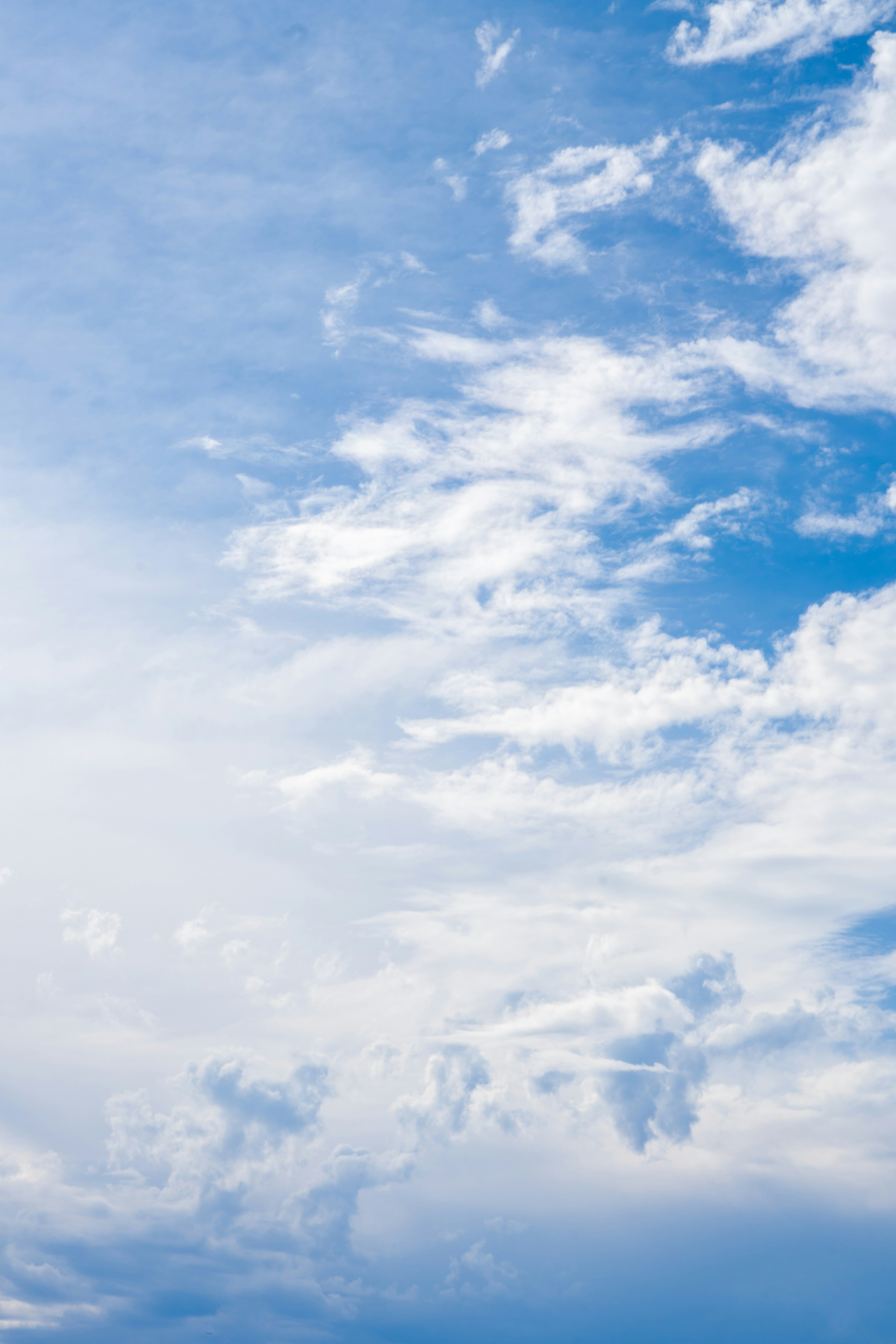 Sky Mosaic: Soft Wisps Across a Serene Blue Canvas