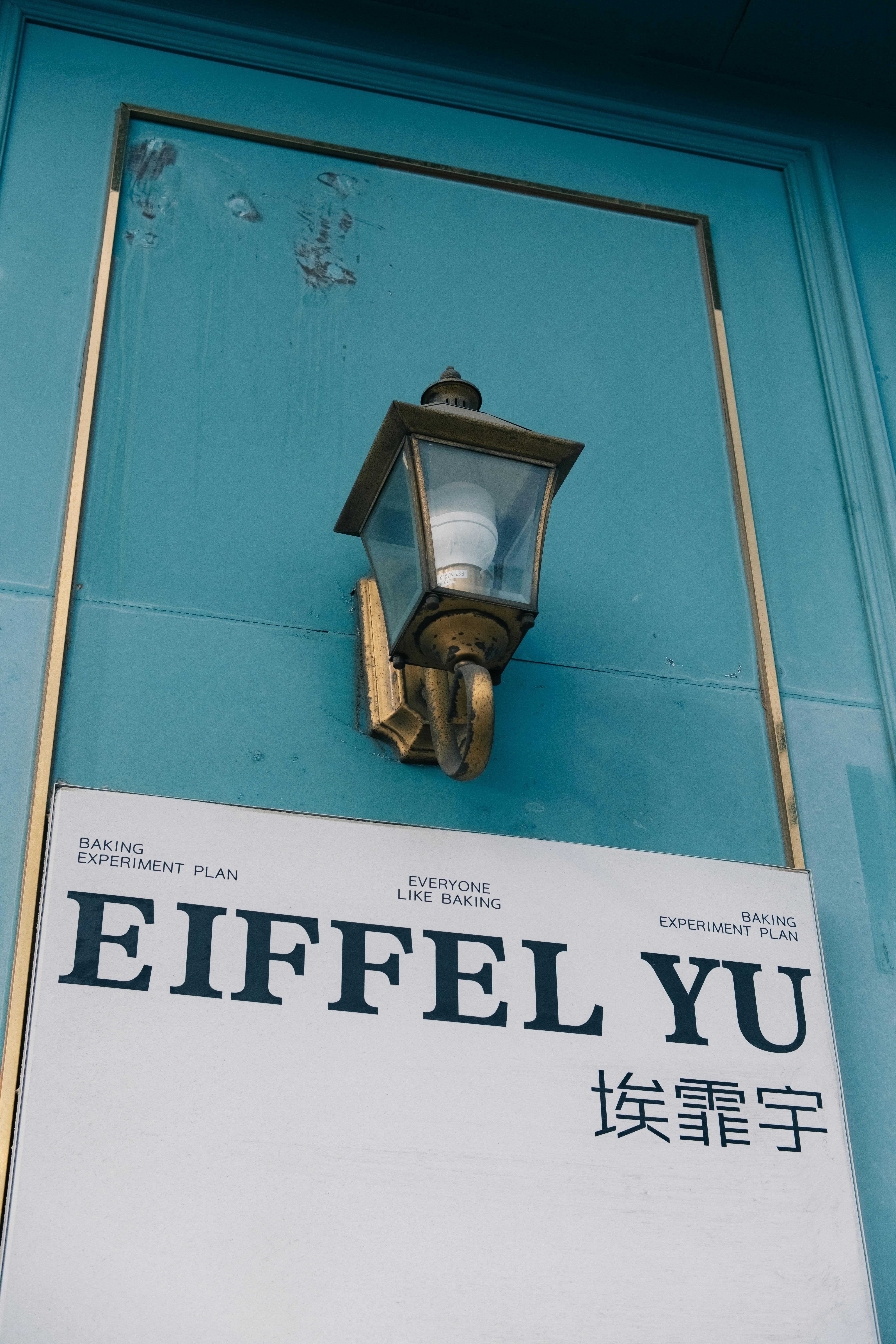 Blue Facade Lantern: Signage Under a Classic Glow