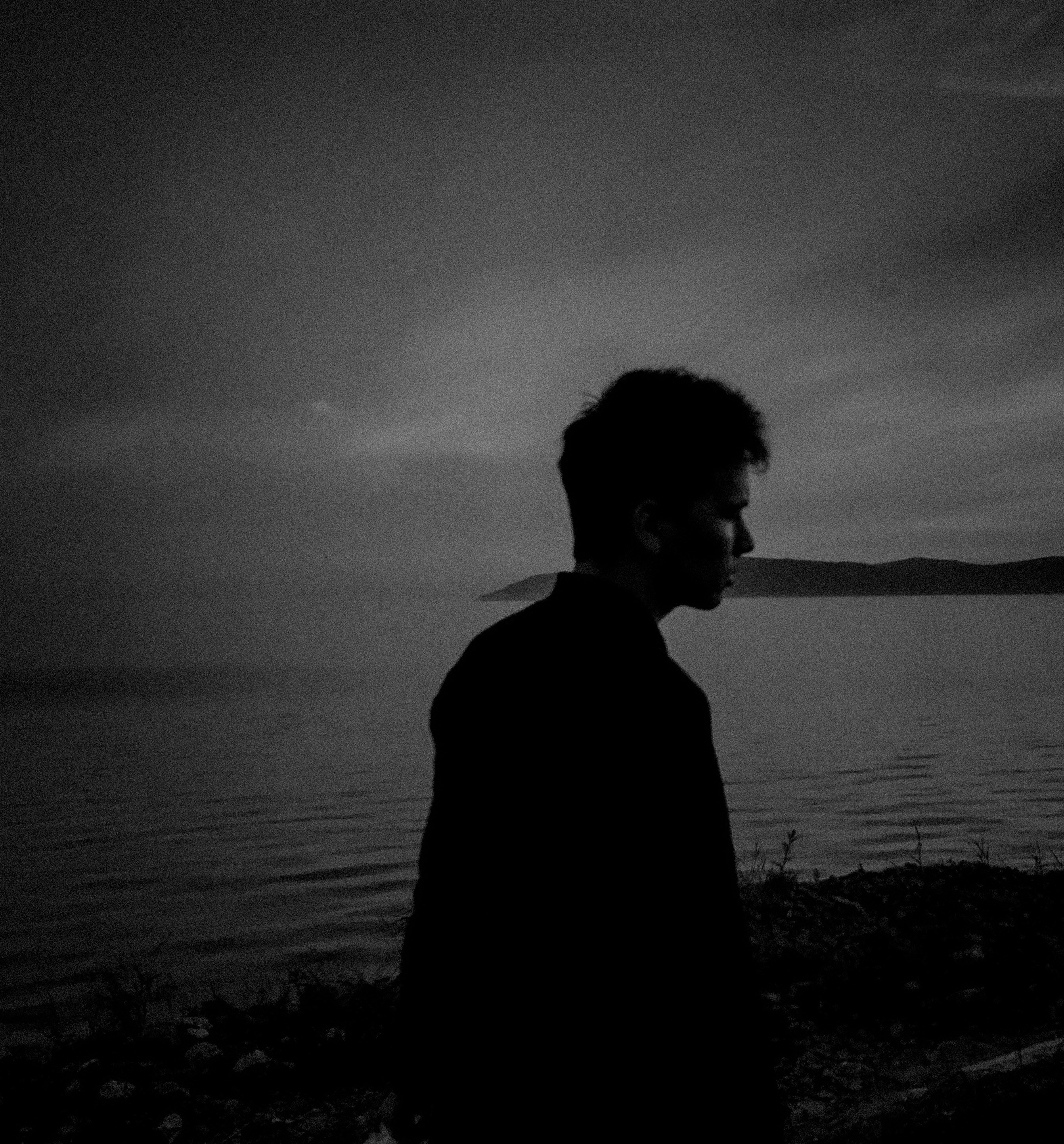Silhouette by the Shoreline at Dusk