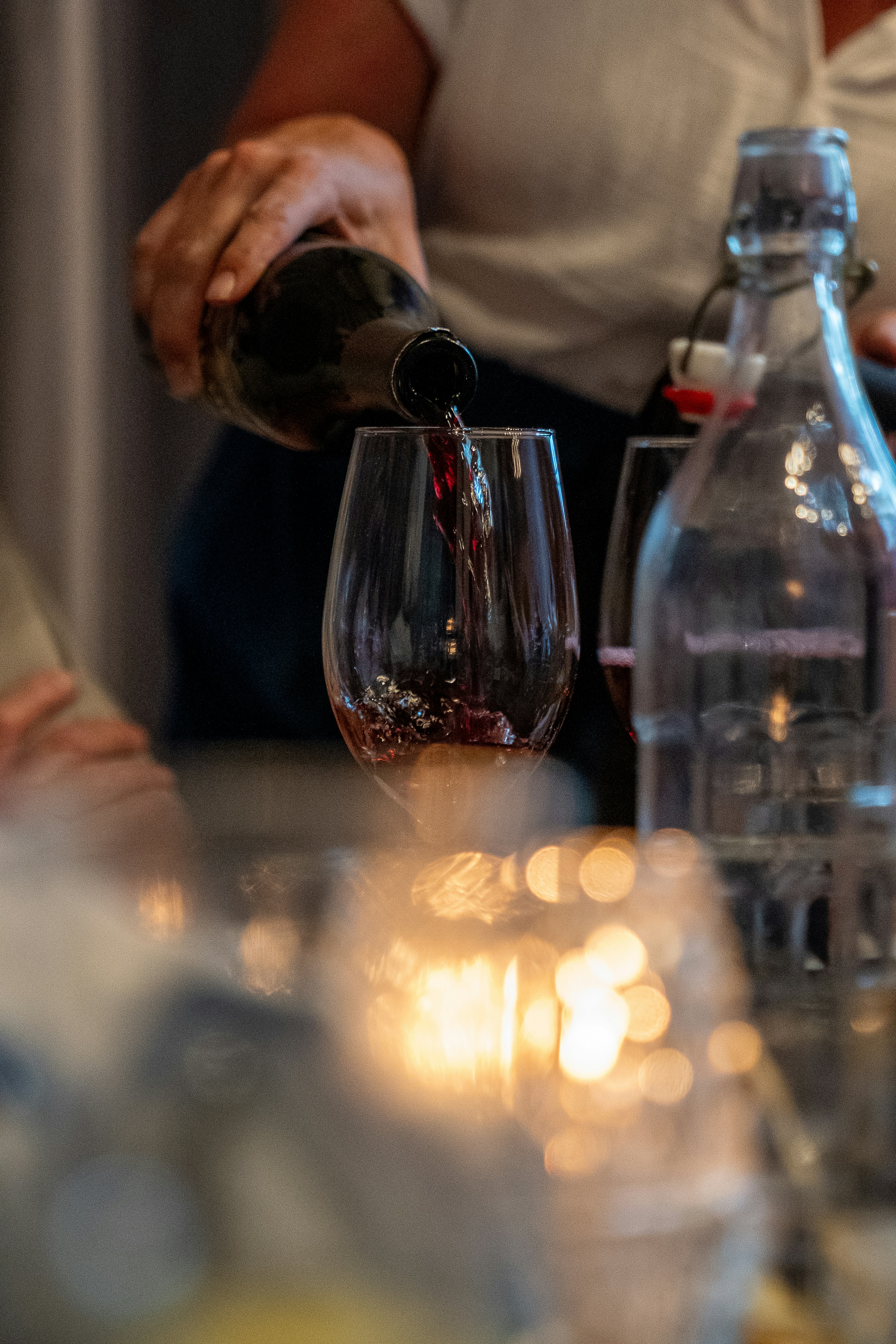 Pouring Red: A Close-Up at the Table Edge