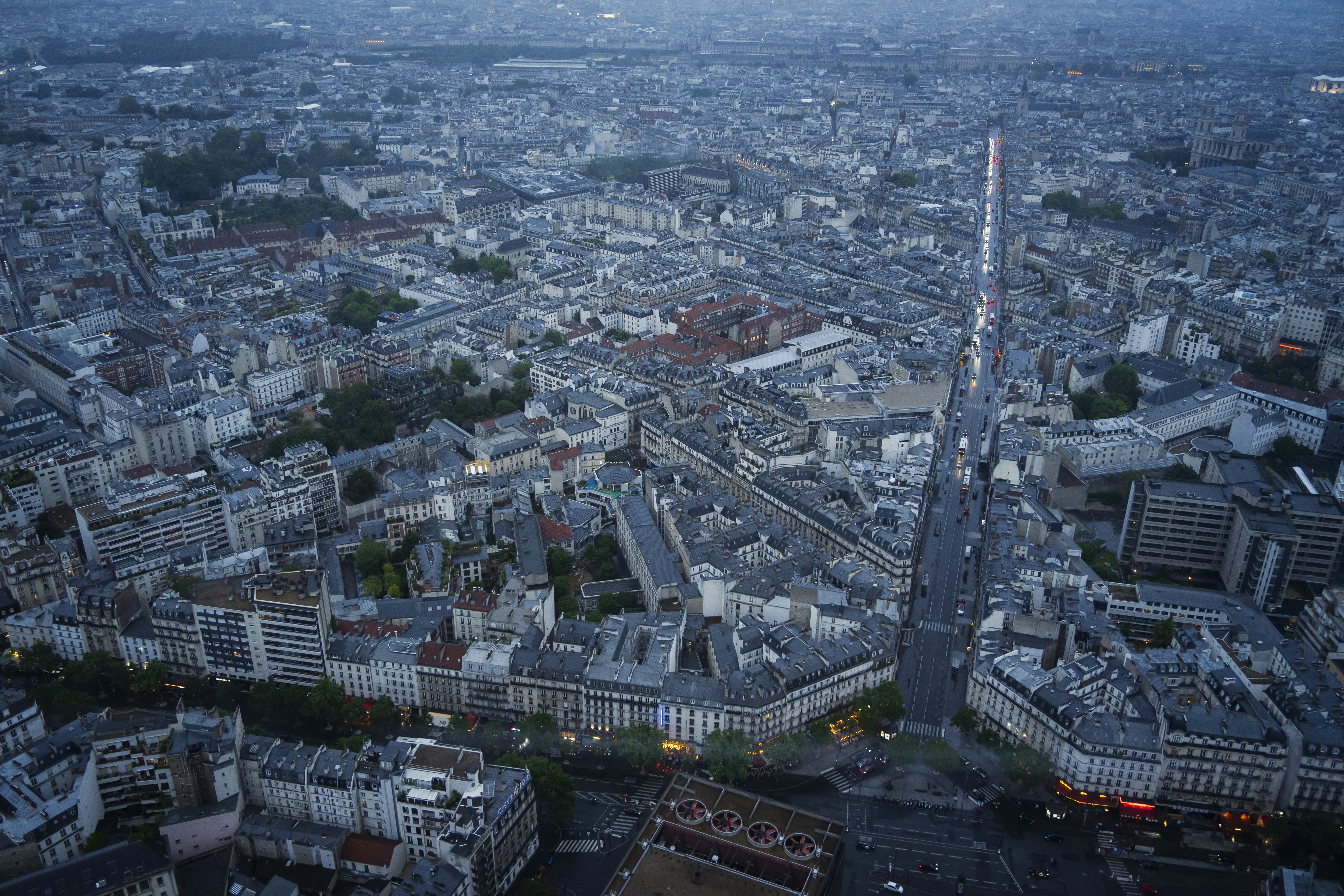 Aerial convergence: narrow spine of a European city cuts through a sea of rooftops