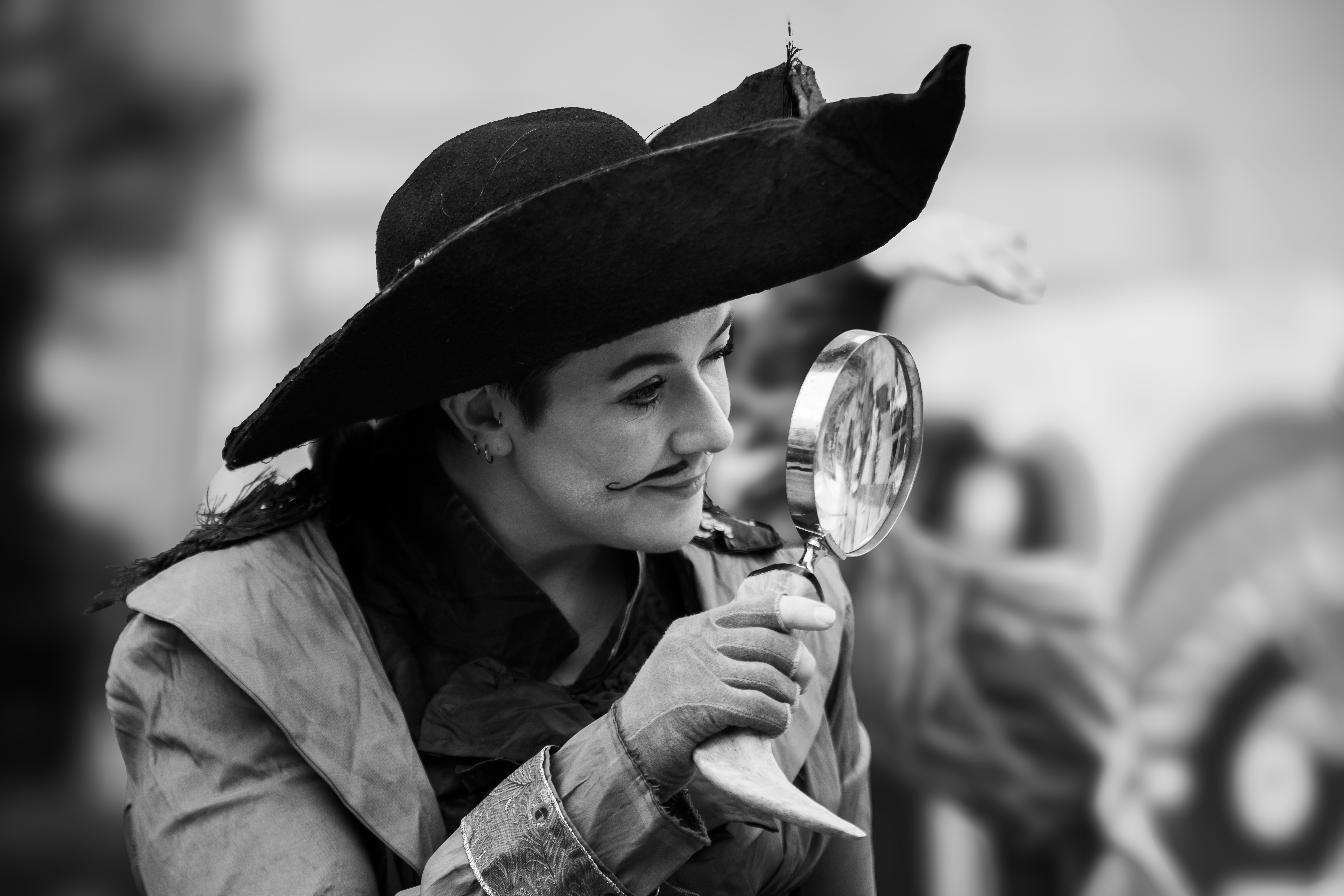 A Gentle Smile Under a Wide Brim: Inspecting Details with a Handheld Mirror