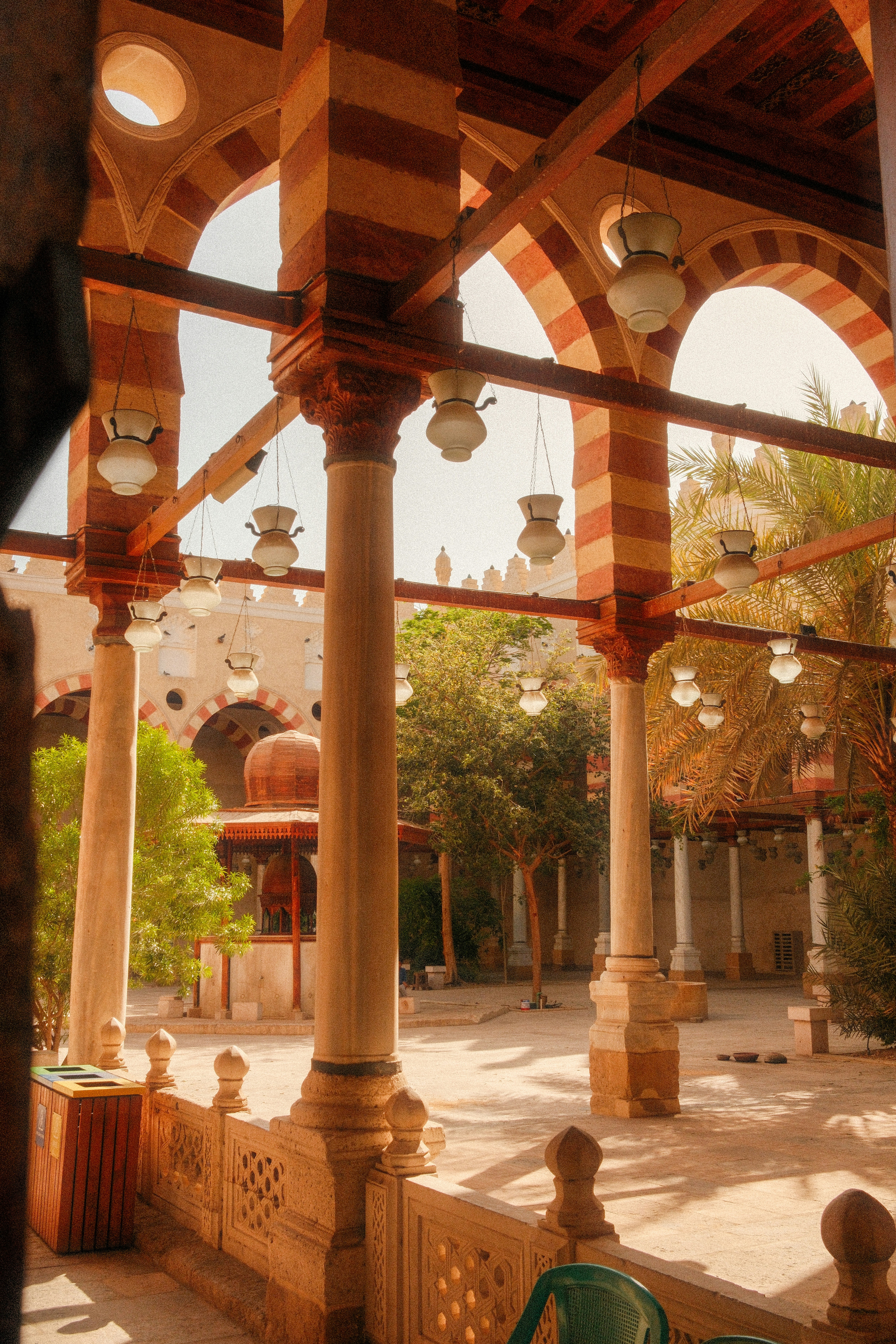 Shade and Stone: Arched Colonnades Framing a Sunny Courtyard