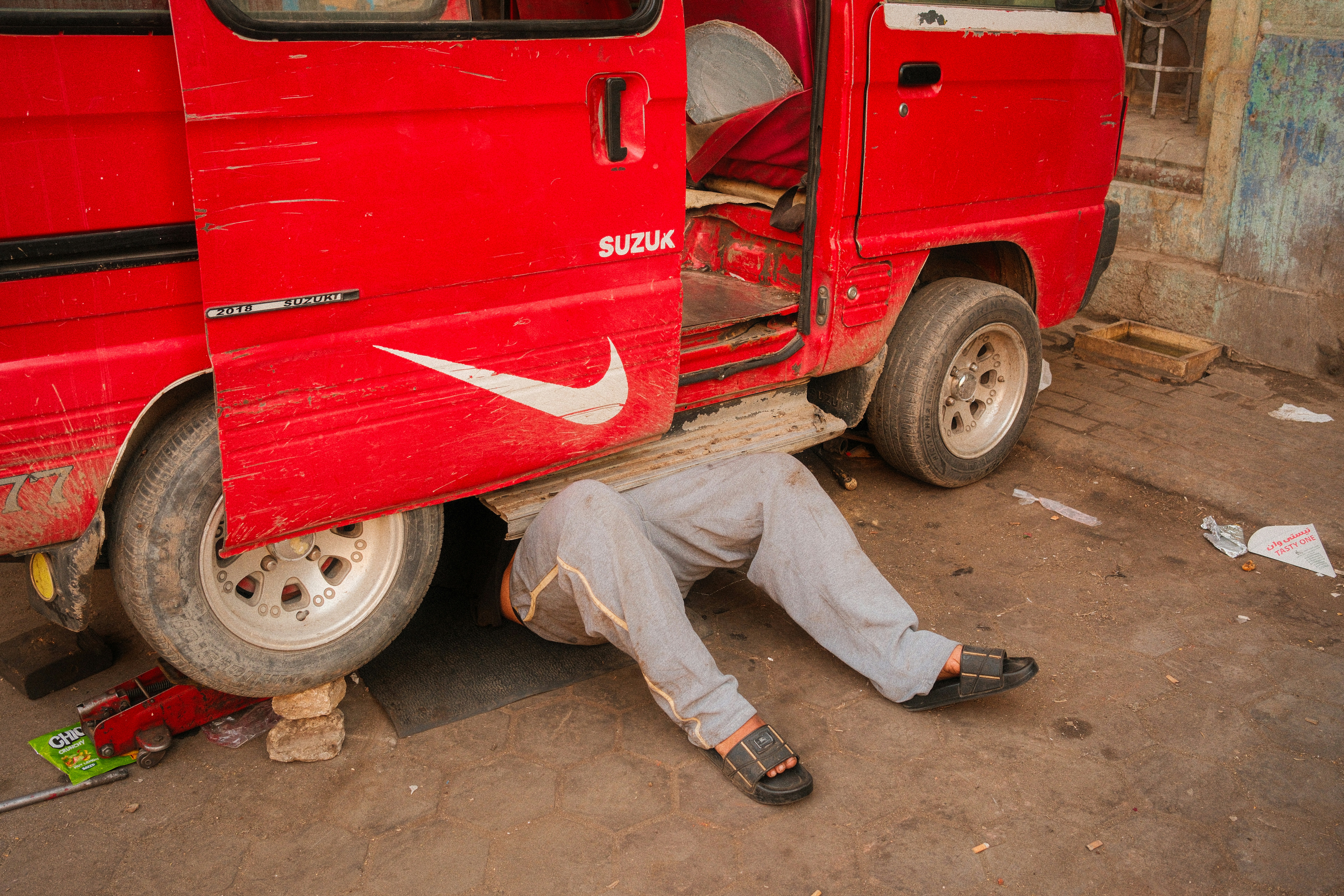 Under the Red Behemoth: A Stray Soul in the Workshop's Shadow