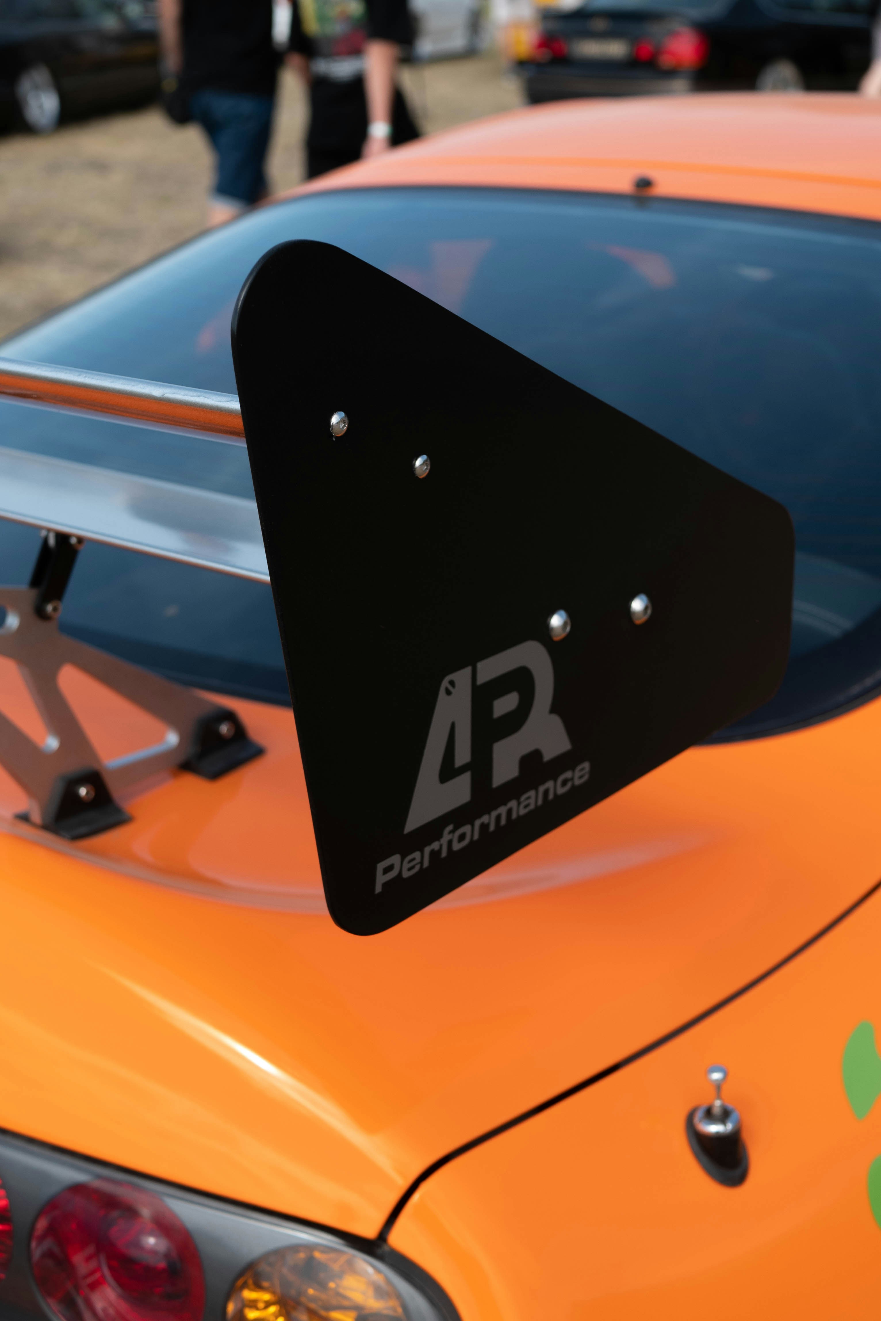 Rear Wing of Orange Racing Car with 4R Performance Logo