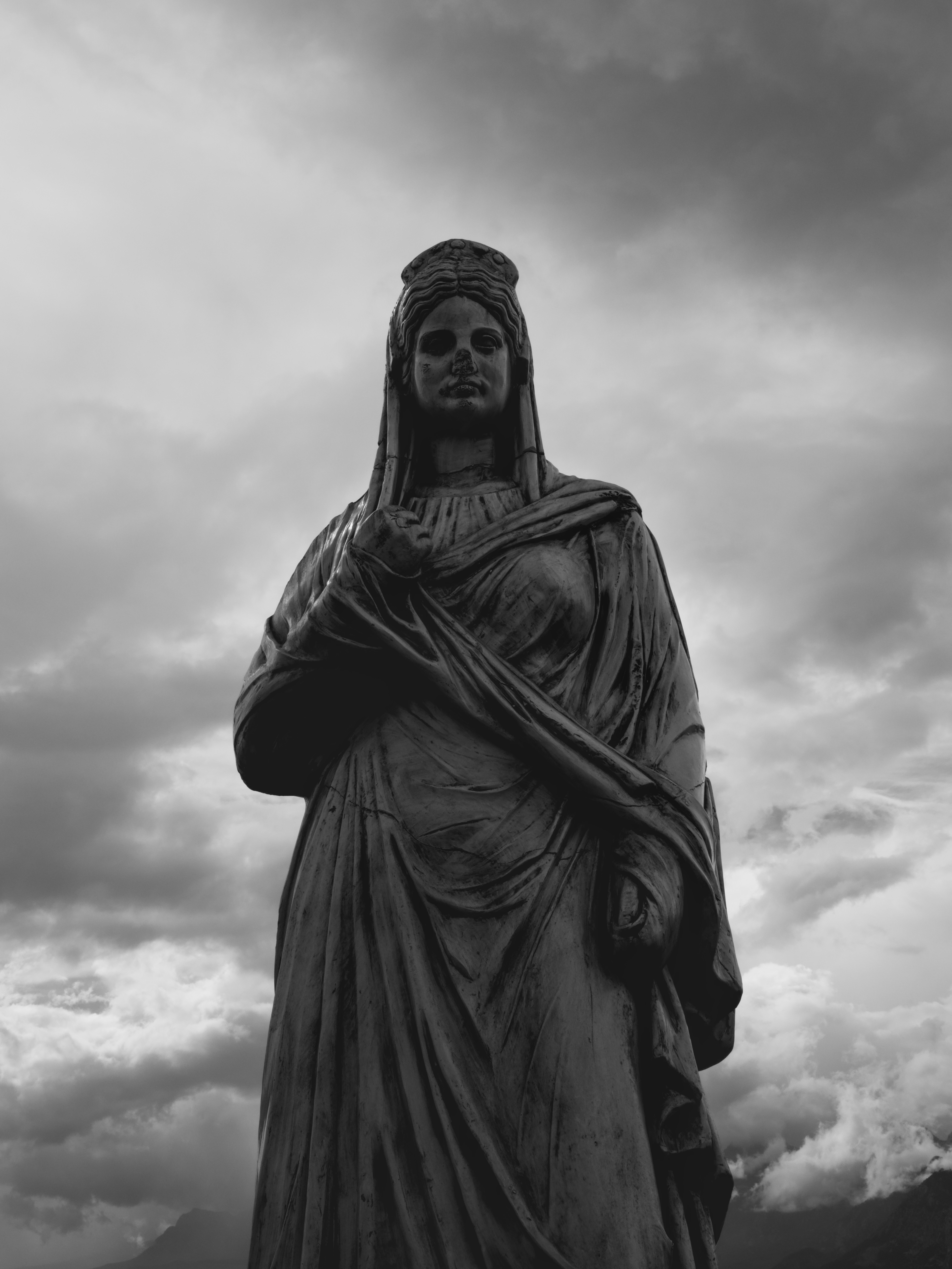 Monumental Gaze: A Stoic Statue Against a Stormy Sky