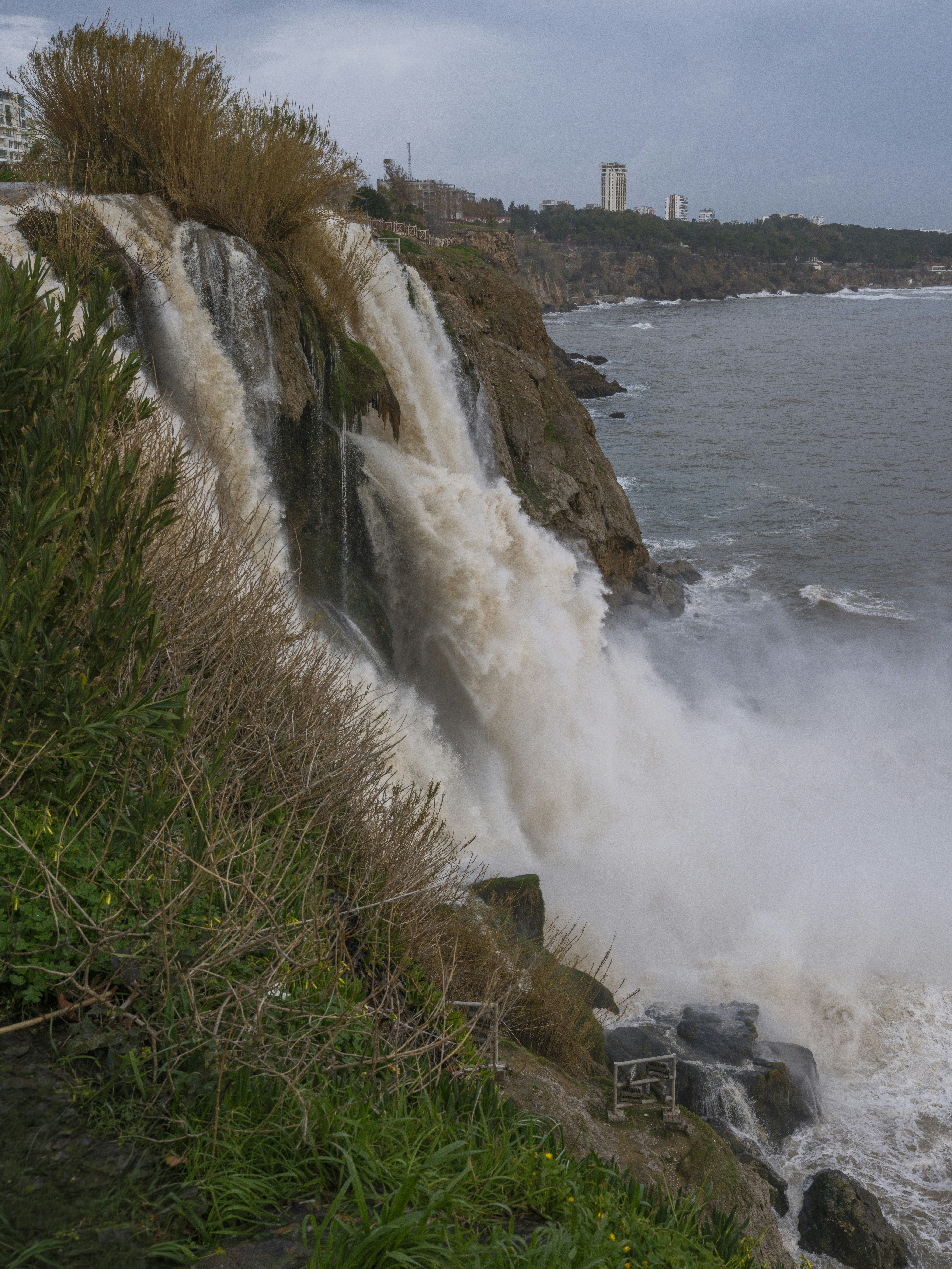 Sea Cliff Surprise: Waterfall Plunging Over Coastal Rocks
