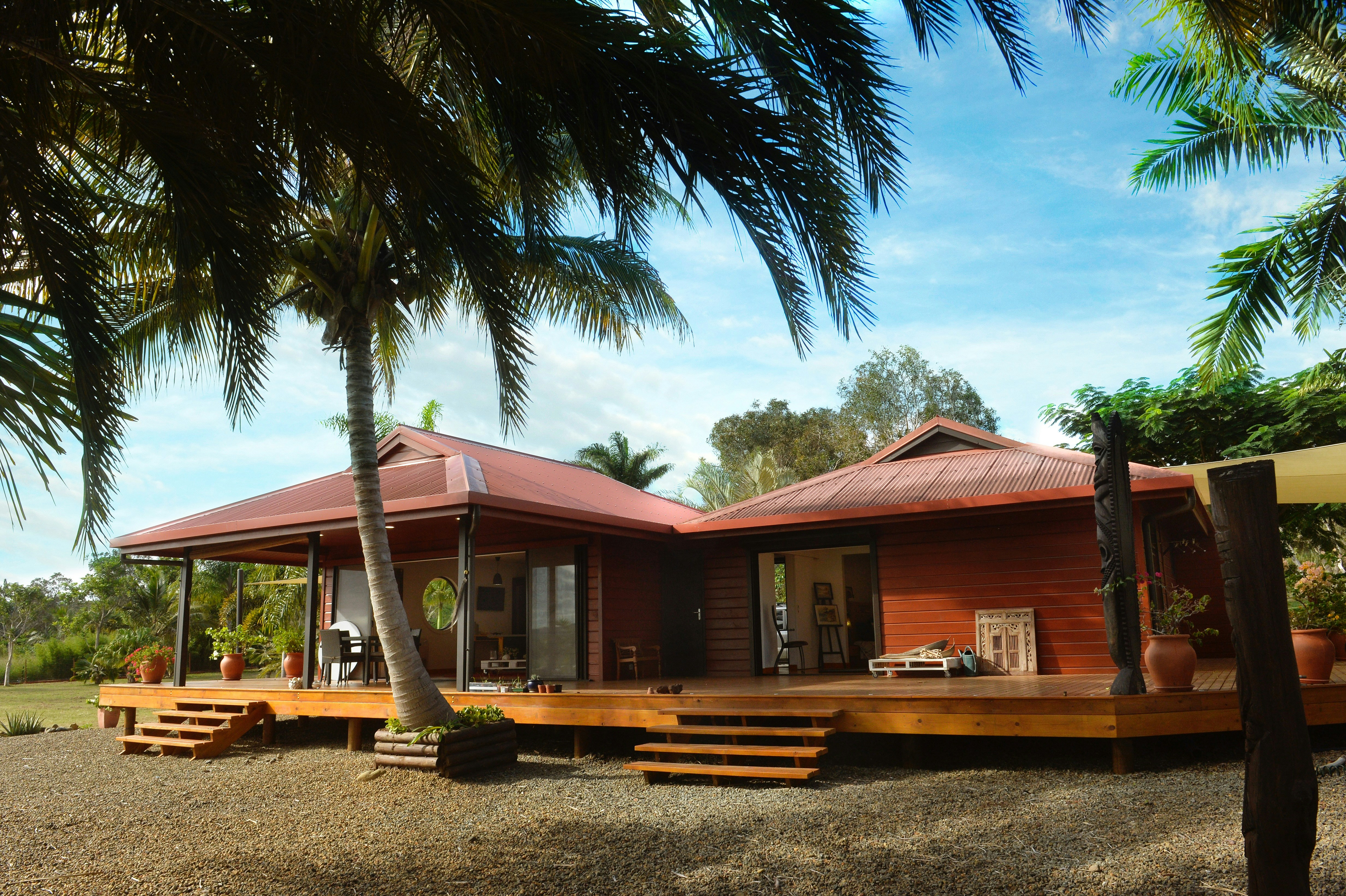Coastal Retreat: A Sunlit Wooden Villa Beneath Framing Palms