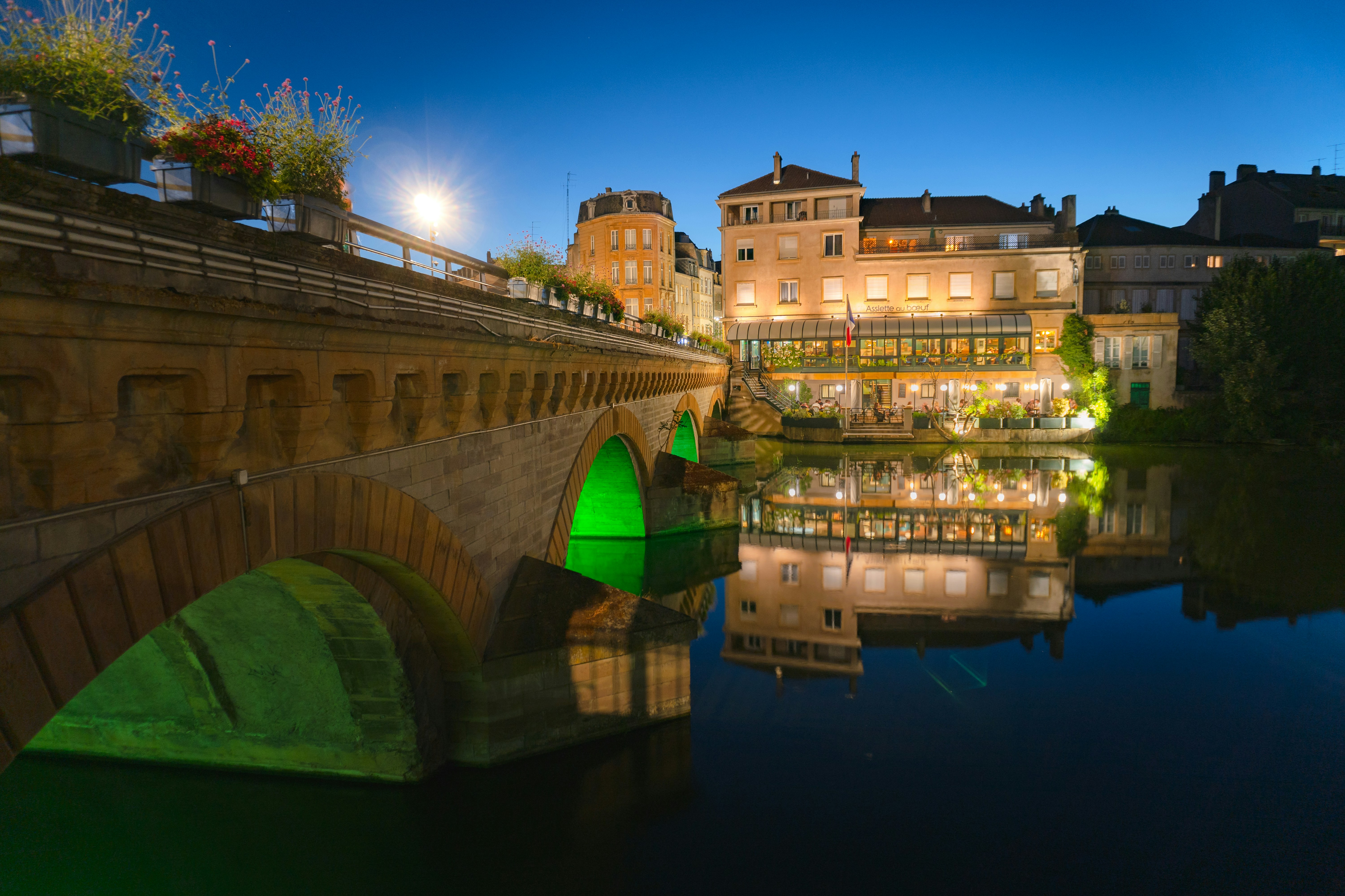 Reflection of the Old Bridge: Nighttime calm along a riverside promenade