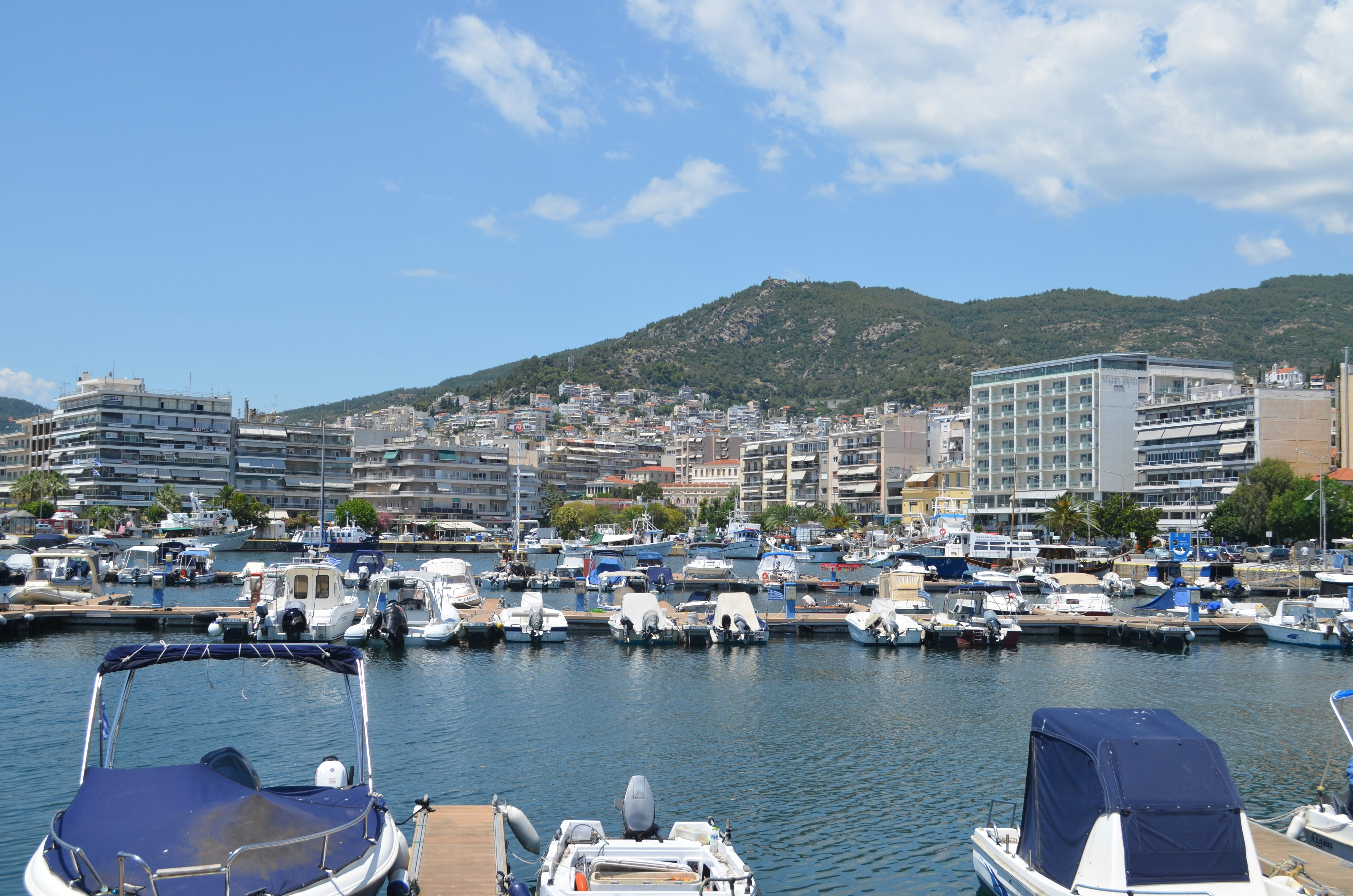 Harbor Mosaic: Boats Lean into Aegean Light Against a Town Shoulder