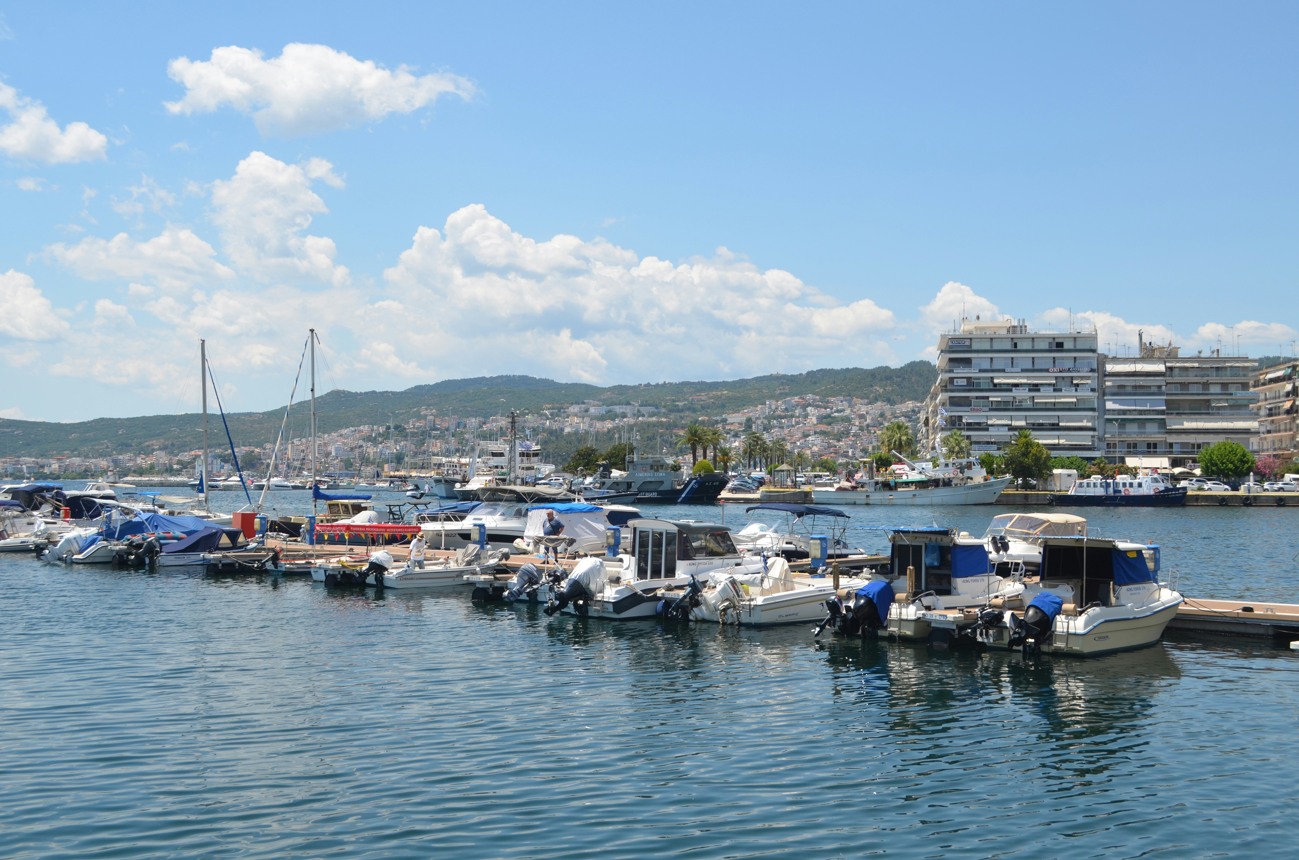 Marina Mosaic: Boats, Docks, and a Cityscape Horizon