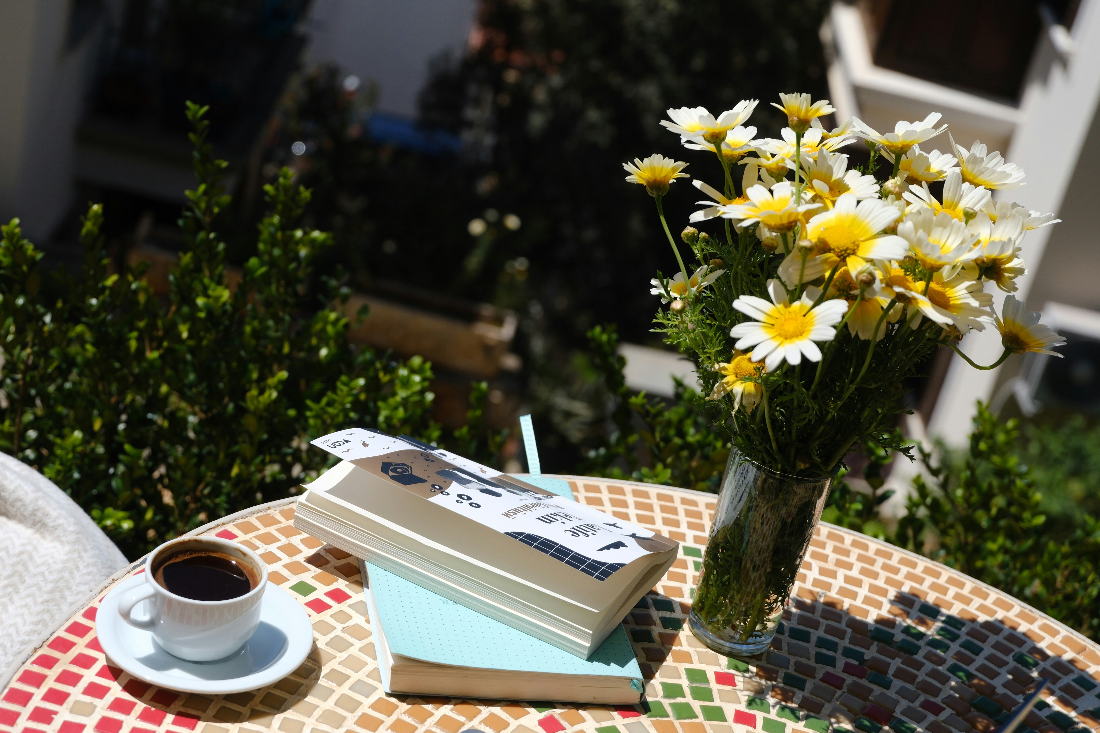 Daisy Bouquet and Reading Moment on Mosaic Table
